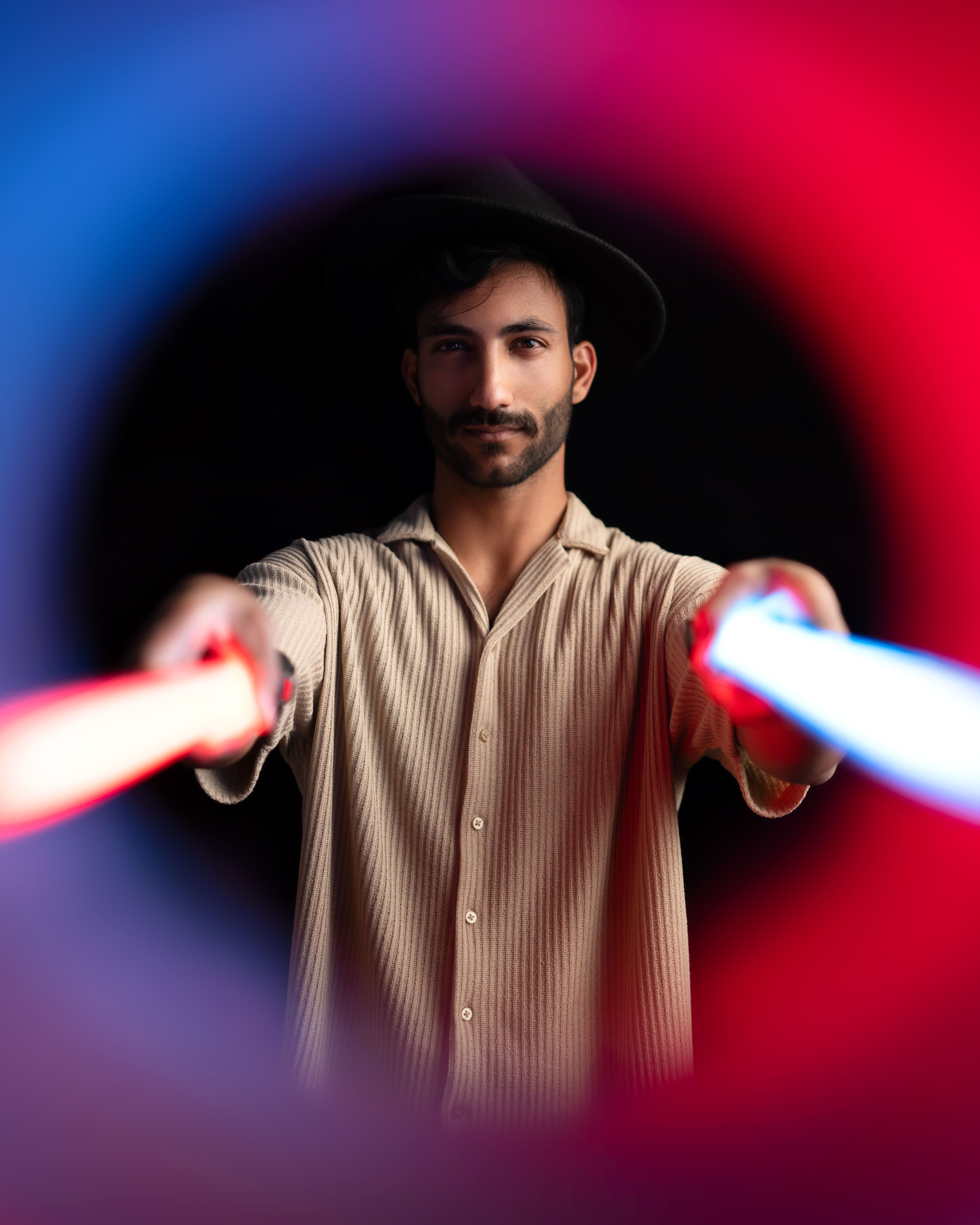 Studio Shot of a Man Holding Bright Red and Blue Lights · Free Stock Photo