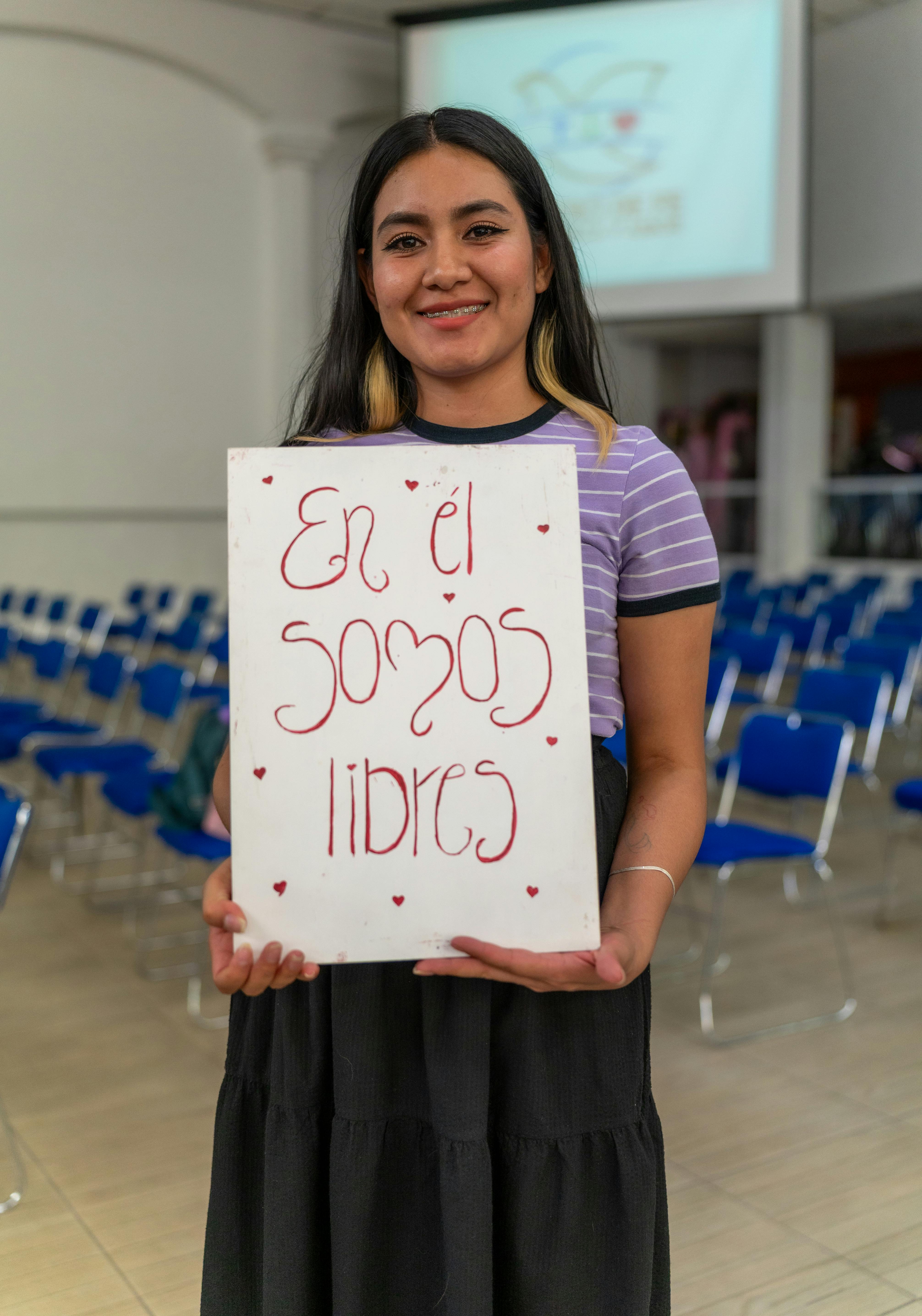 Close-up Portrait of a Woman with a Sign · Free Stock Photo