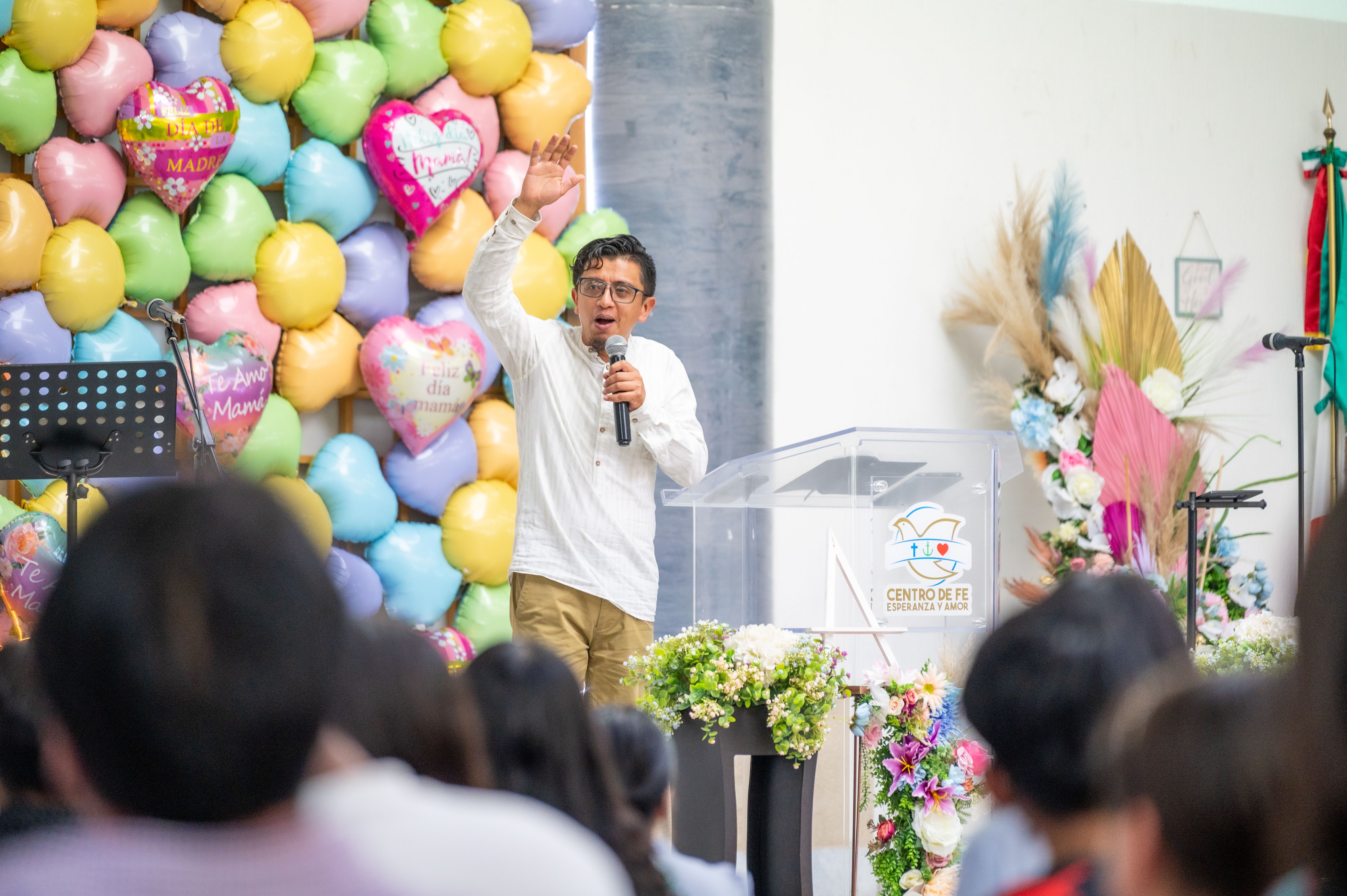 Man Speaking to a Microphone on a Pulpit and Leading a Prayer Meeting ...