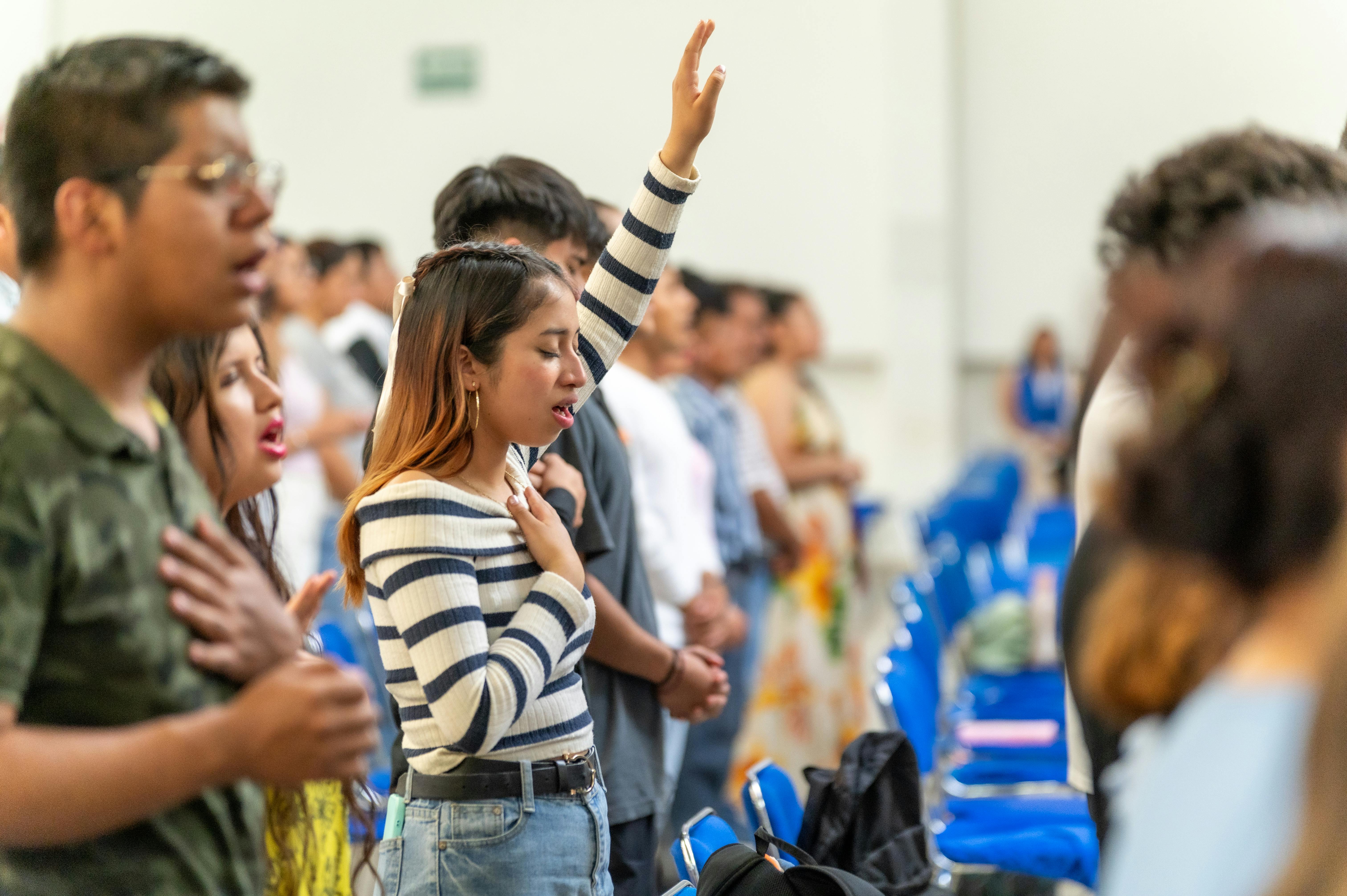 Group of People Standing and Praying in a Church · Free Stock Photo