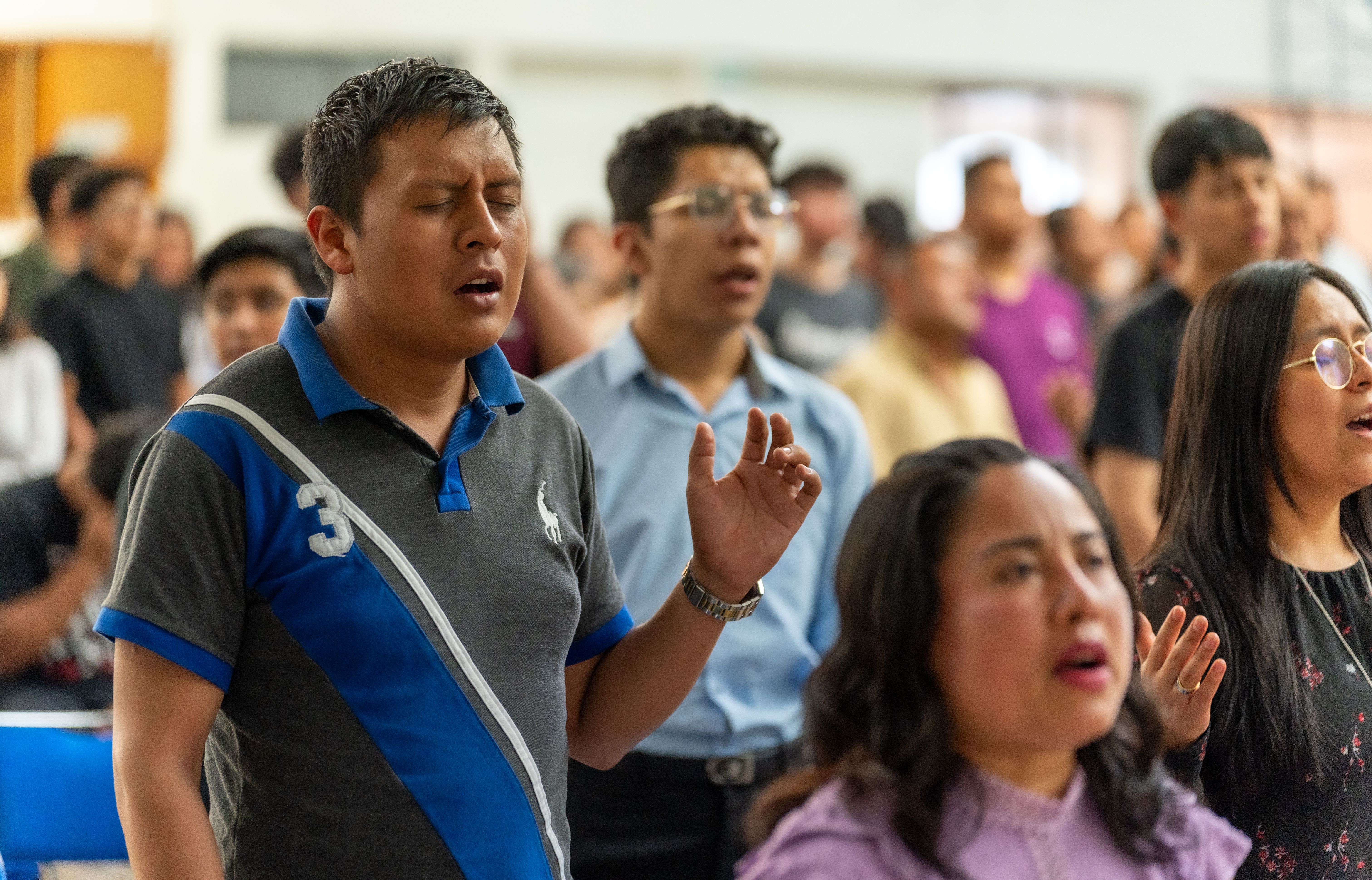 A group of people in a church singing · Free Stock Photo