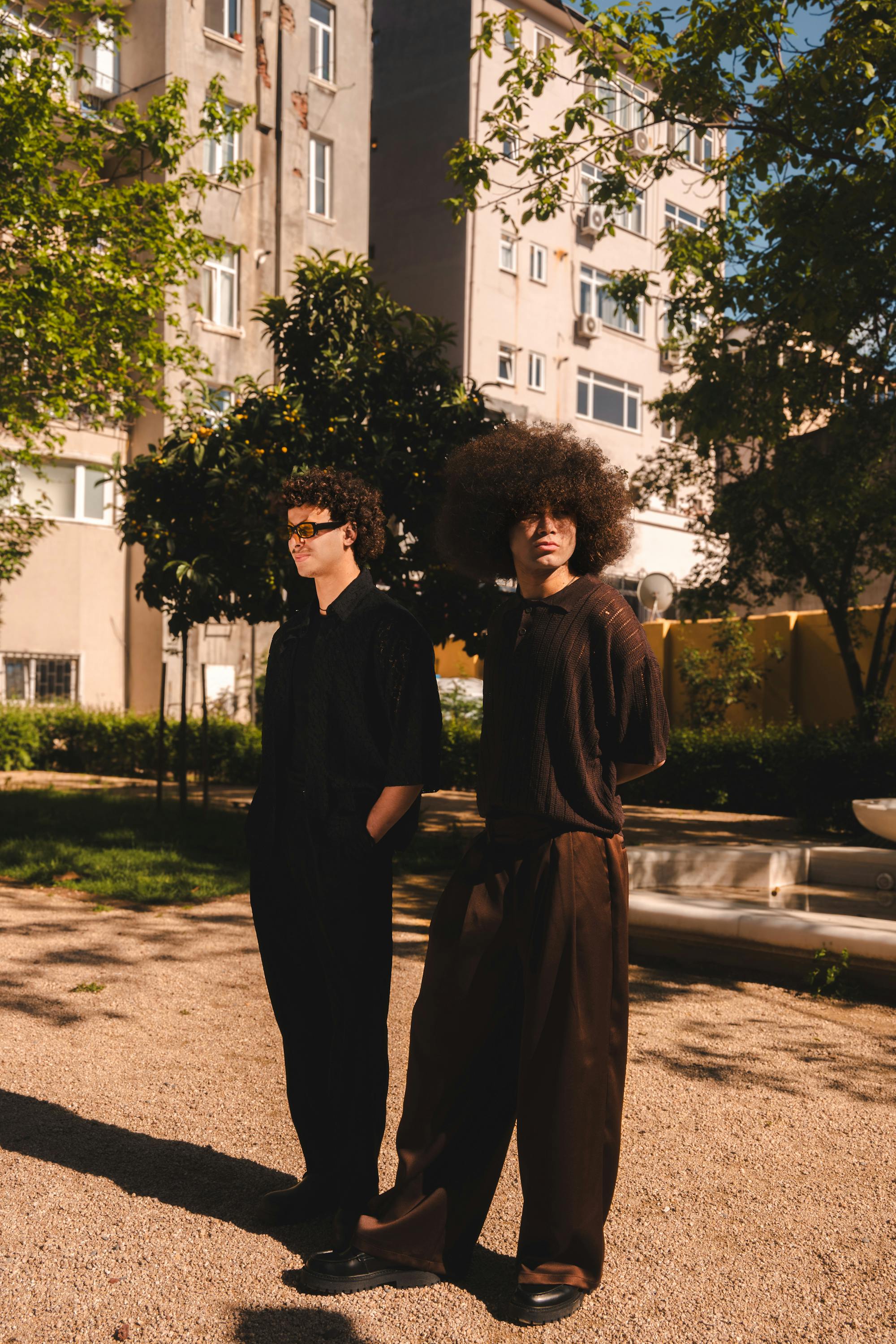 Two Male Models Standing Outdoors Side by Side · Free Stock Photo