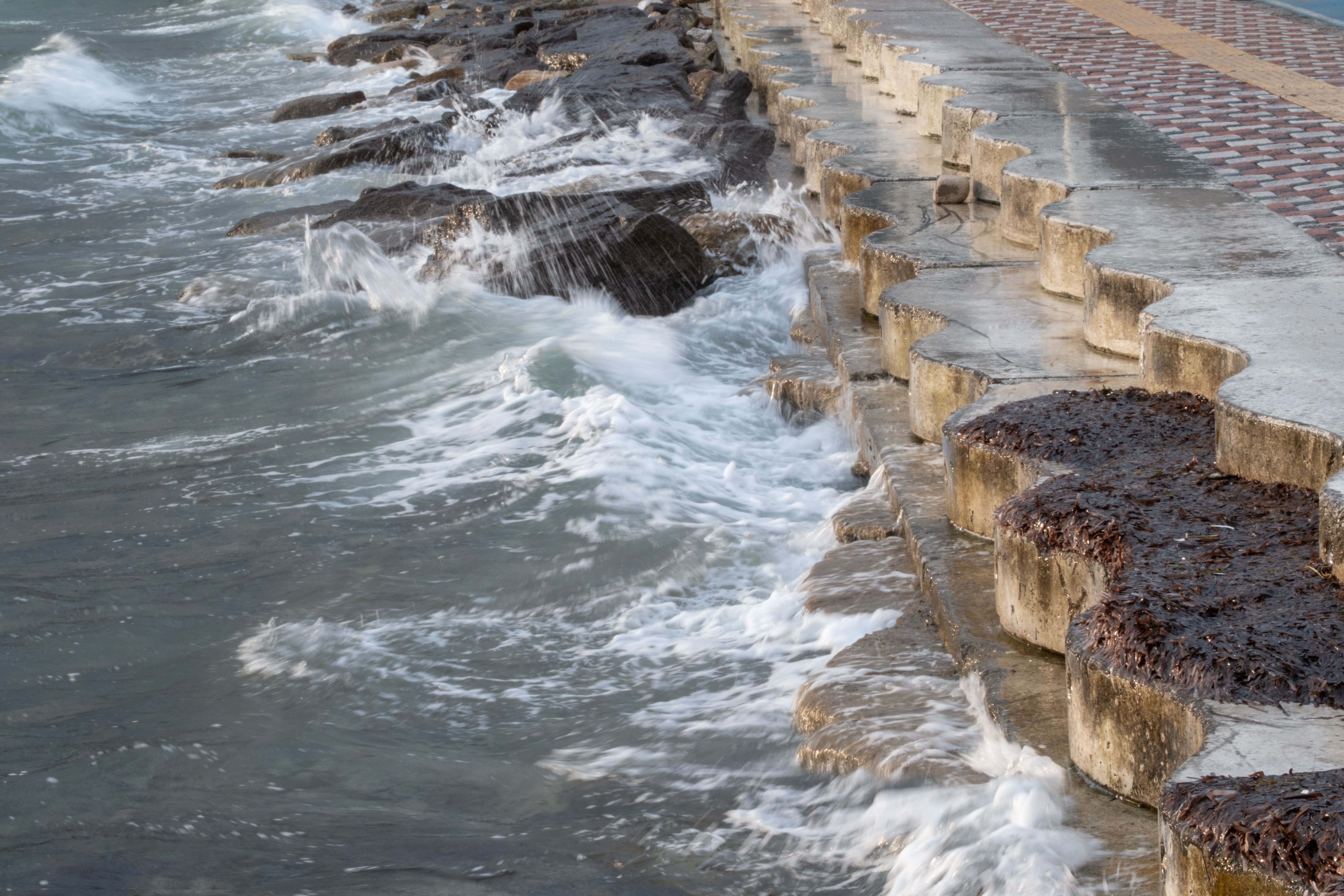 Wave Crashing Against Rocks and Promenade · Free Stock Photo