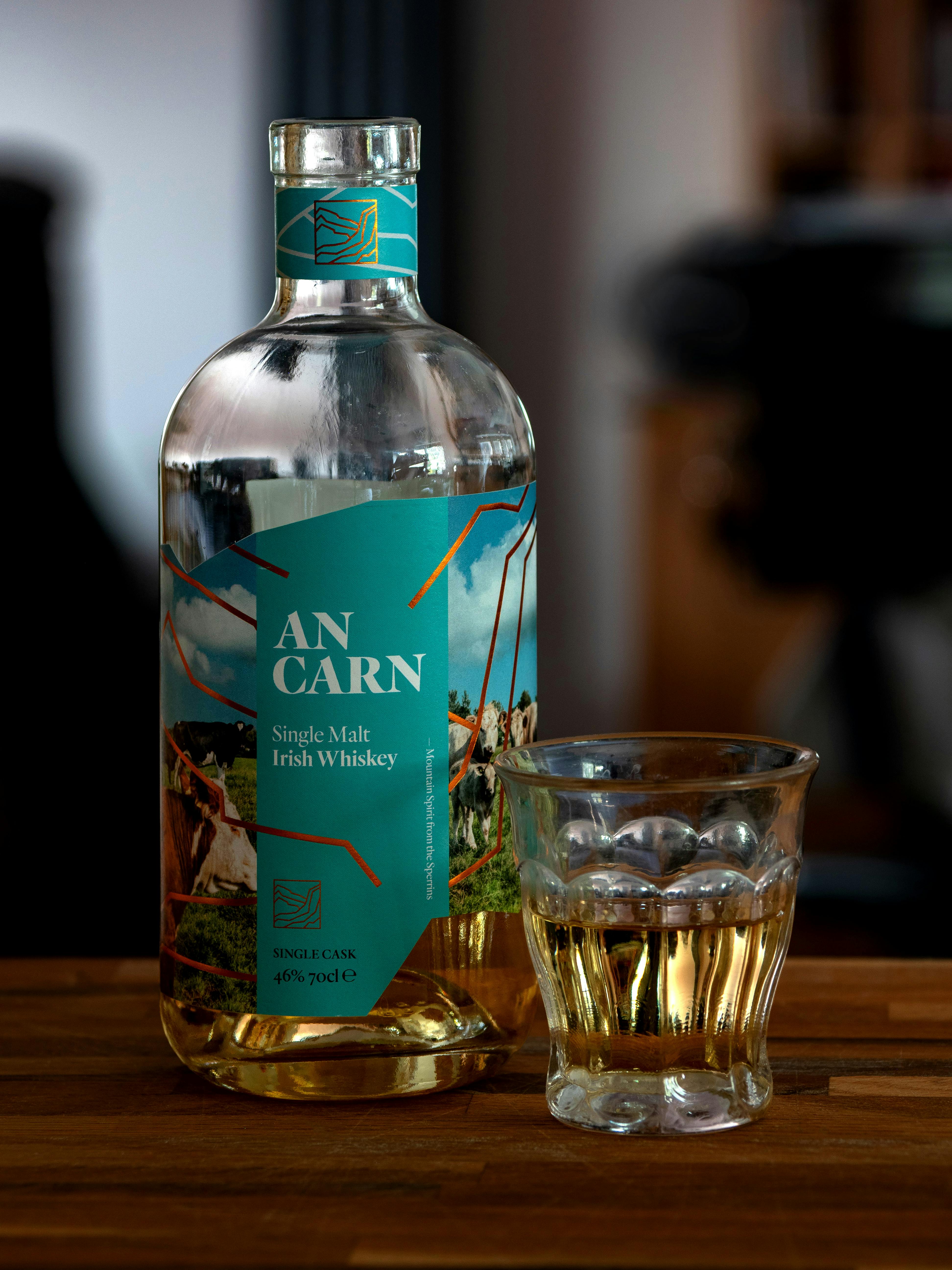 Glass of An Carn Irish Whiskey next to Bottle · Free Stock Photo