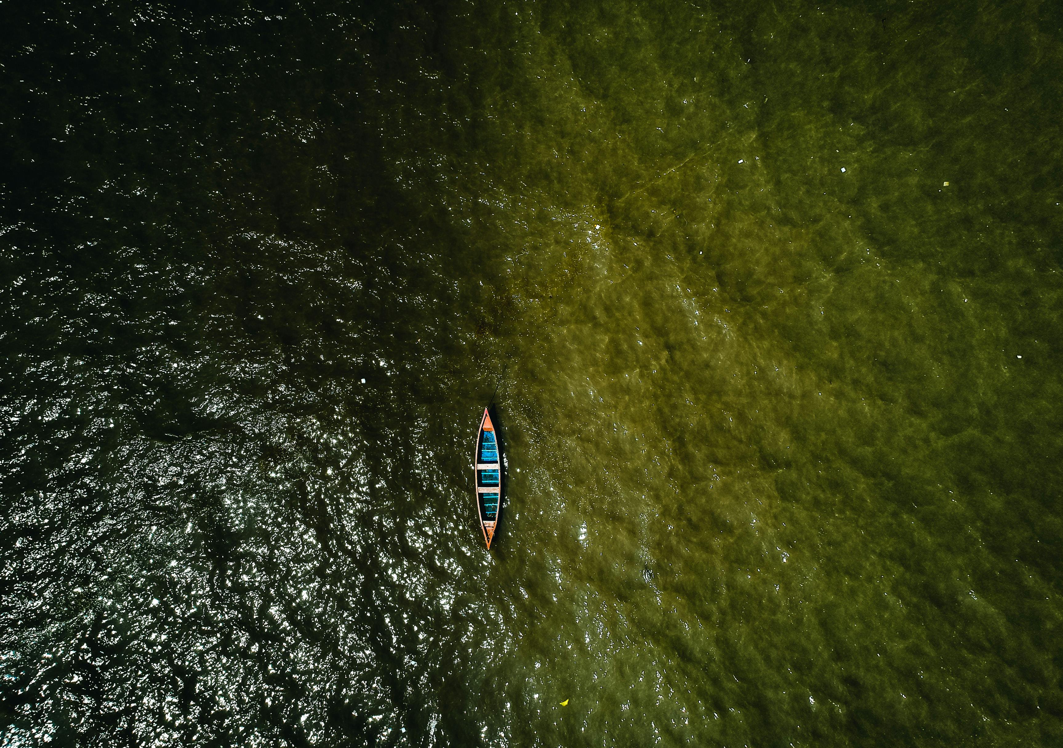 Aerial View Black Wooden Row Boat on Body of Water · Free Stock Photo