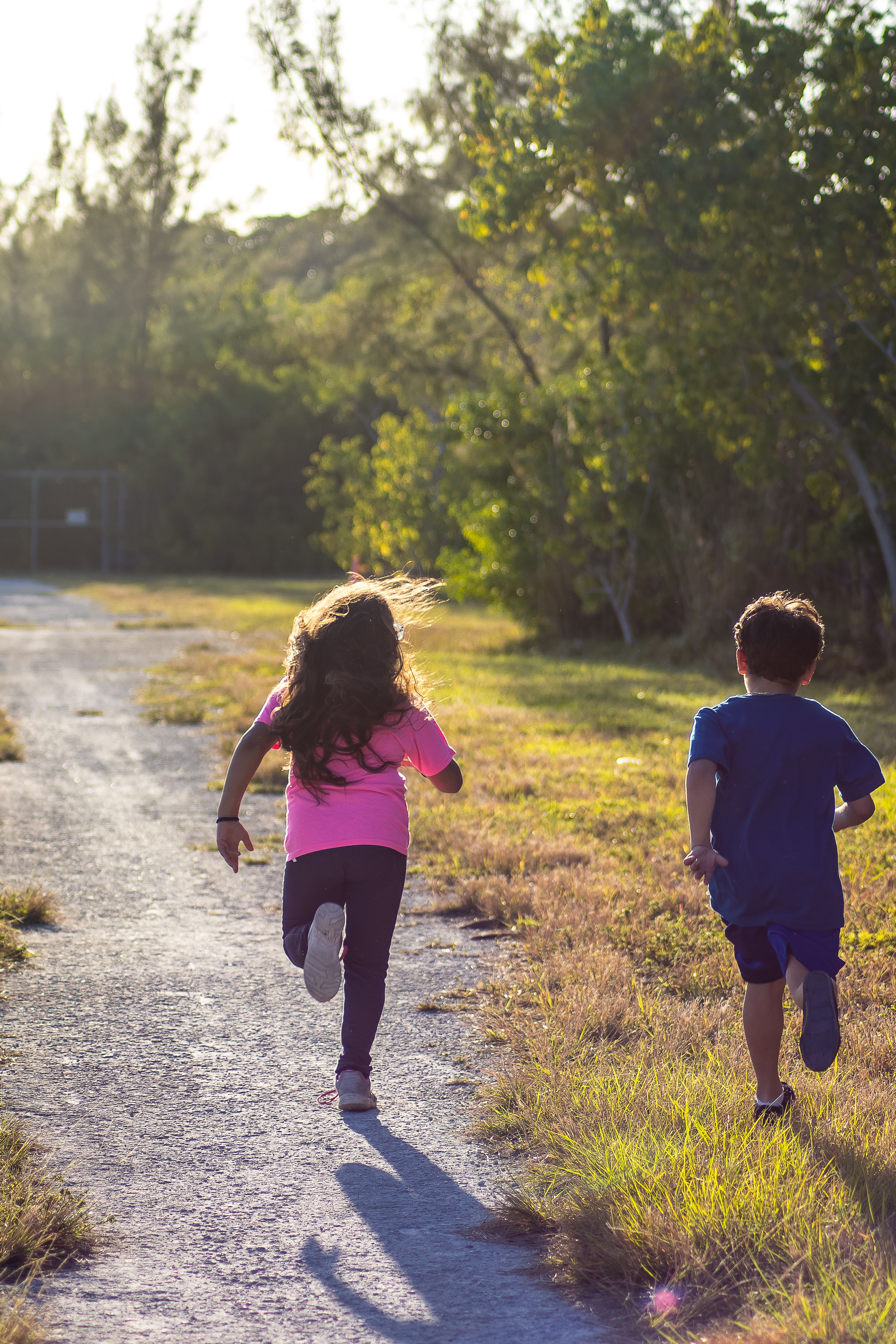Two Children Running in a Park · Free Stock Photo