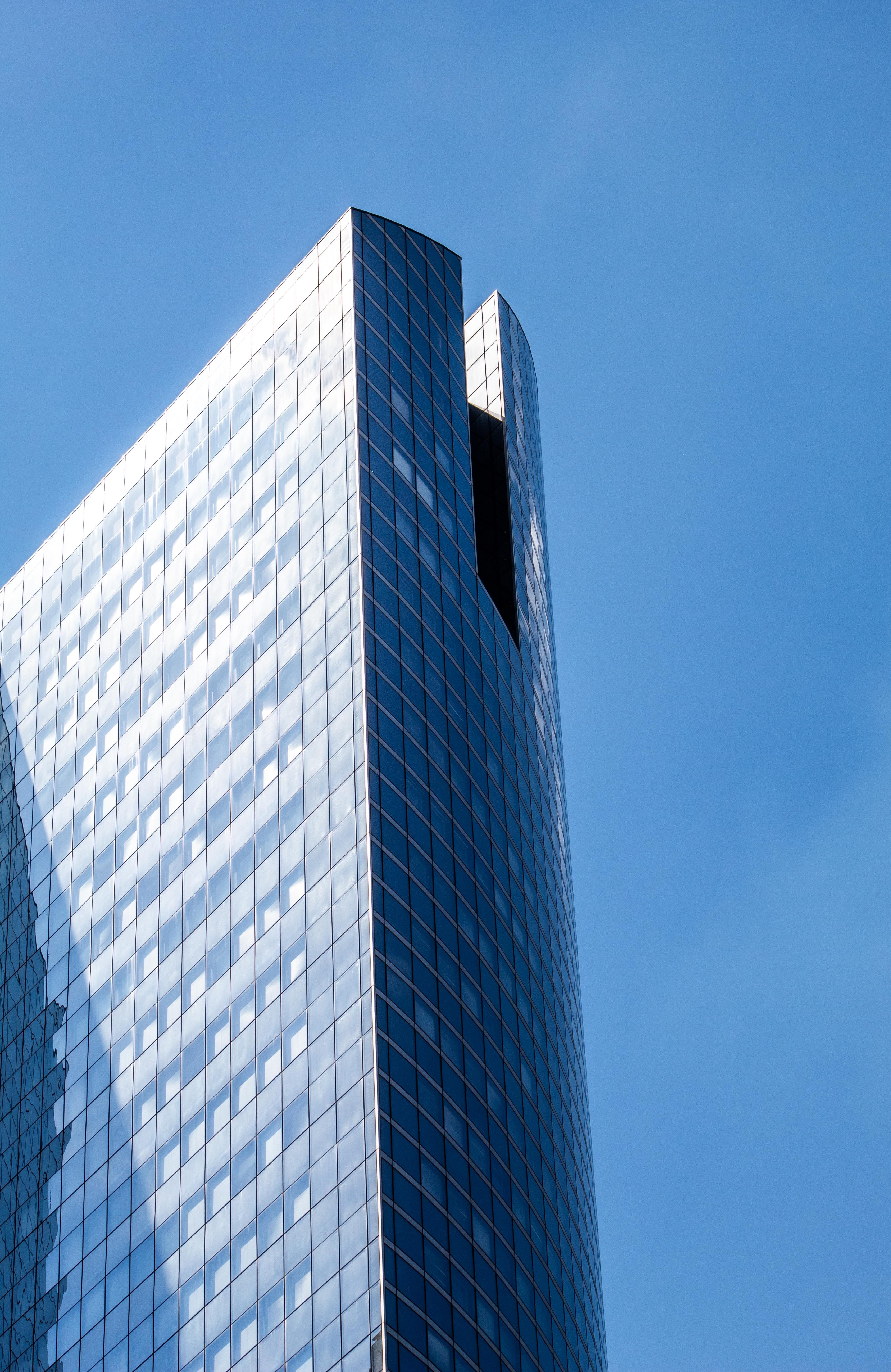 Low Angle Shot of a Modern Skyscraper under a Clear, Blue Sky · Free ...