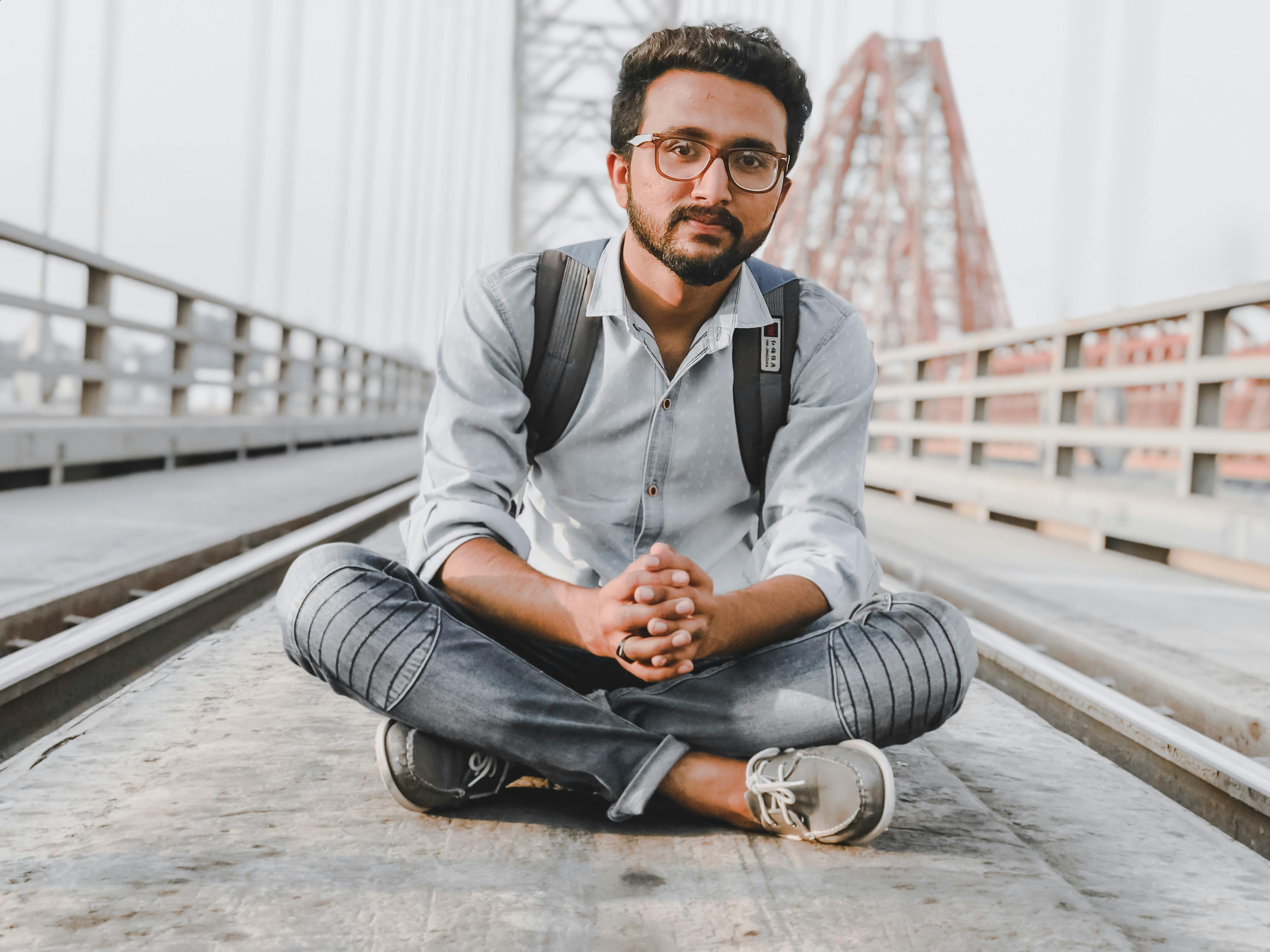 Man Sitting on Bridge · Free Stock Photo
