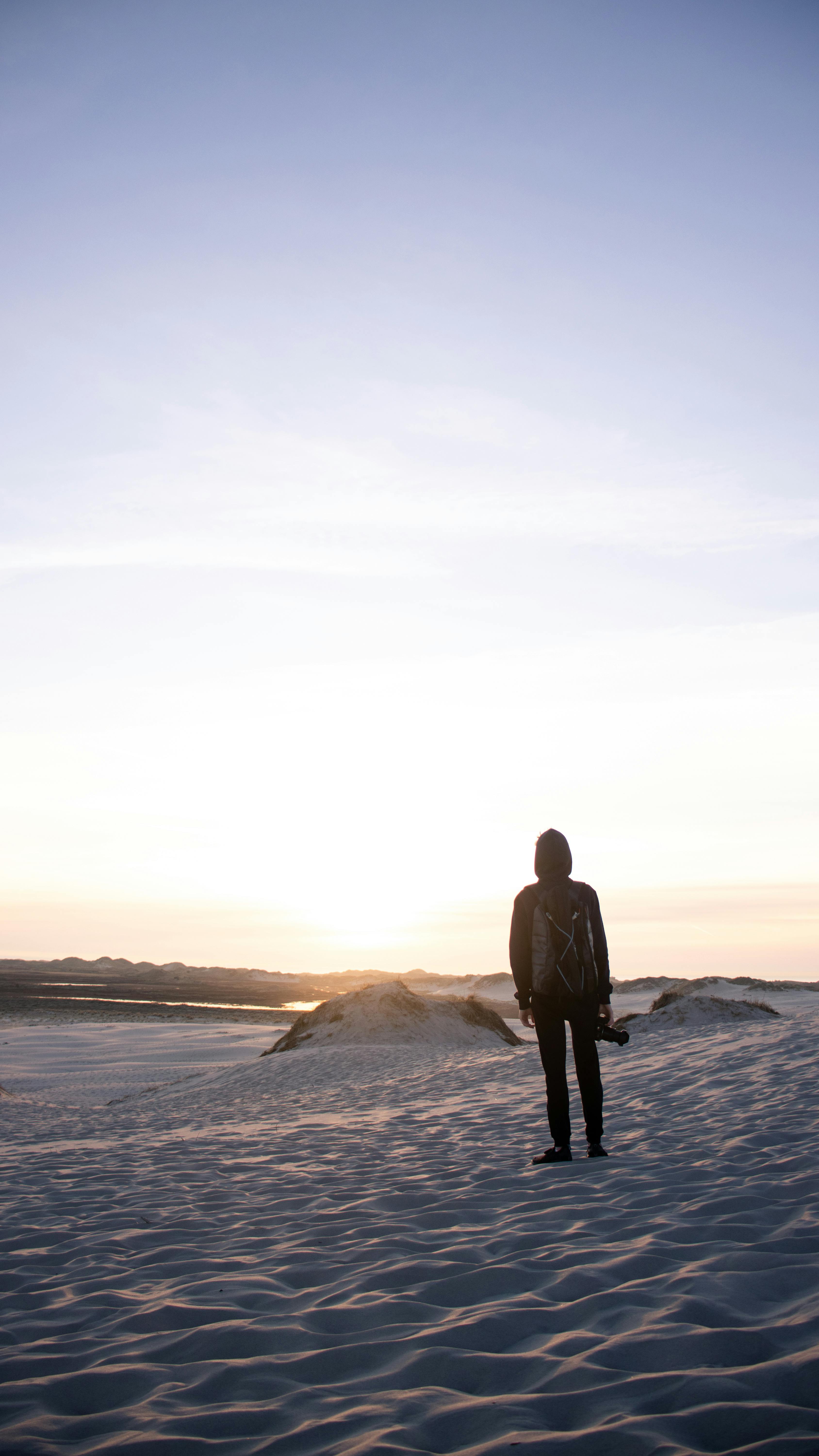 Free stock photo of Guy standing in sand dunes