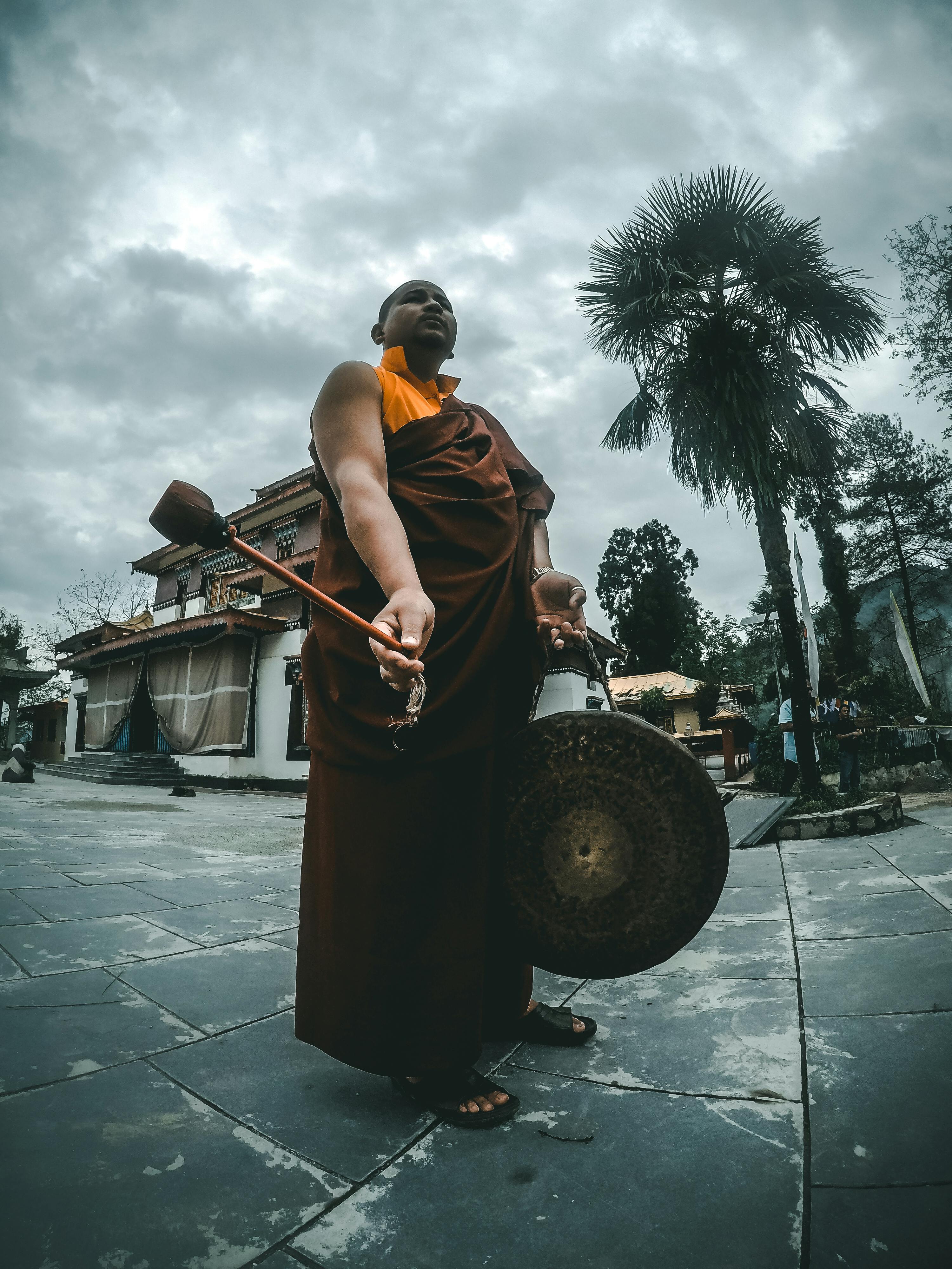 Monk Holding Bell · Free Stock Photo