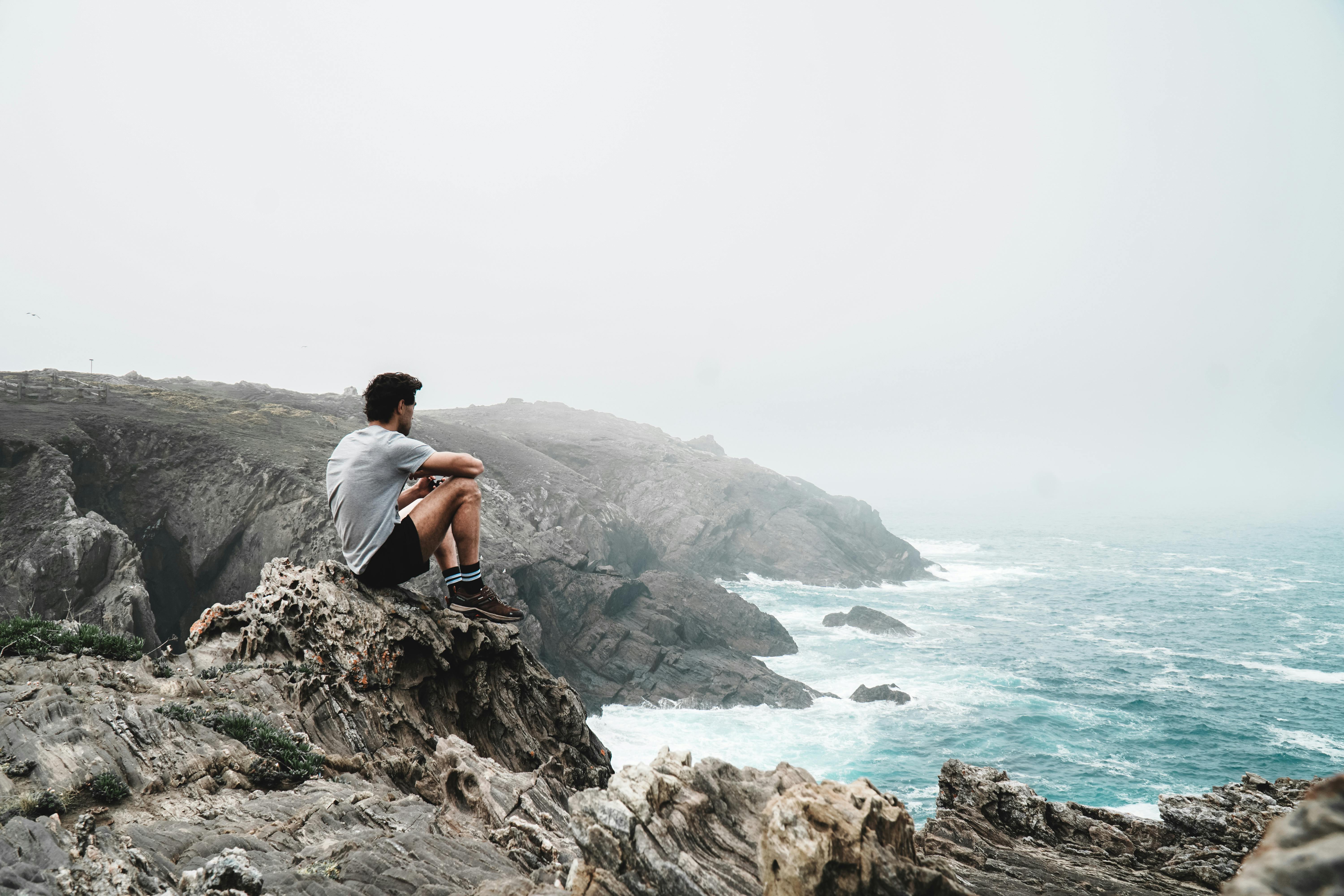 Man Riding on Brown Rock Formation · Free Stock Photo