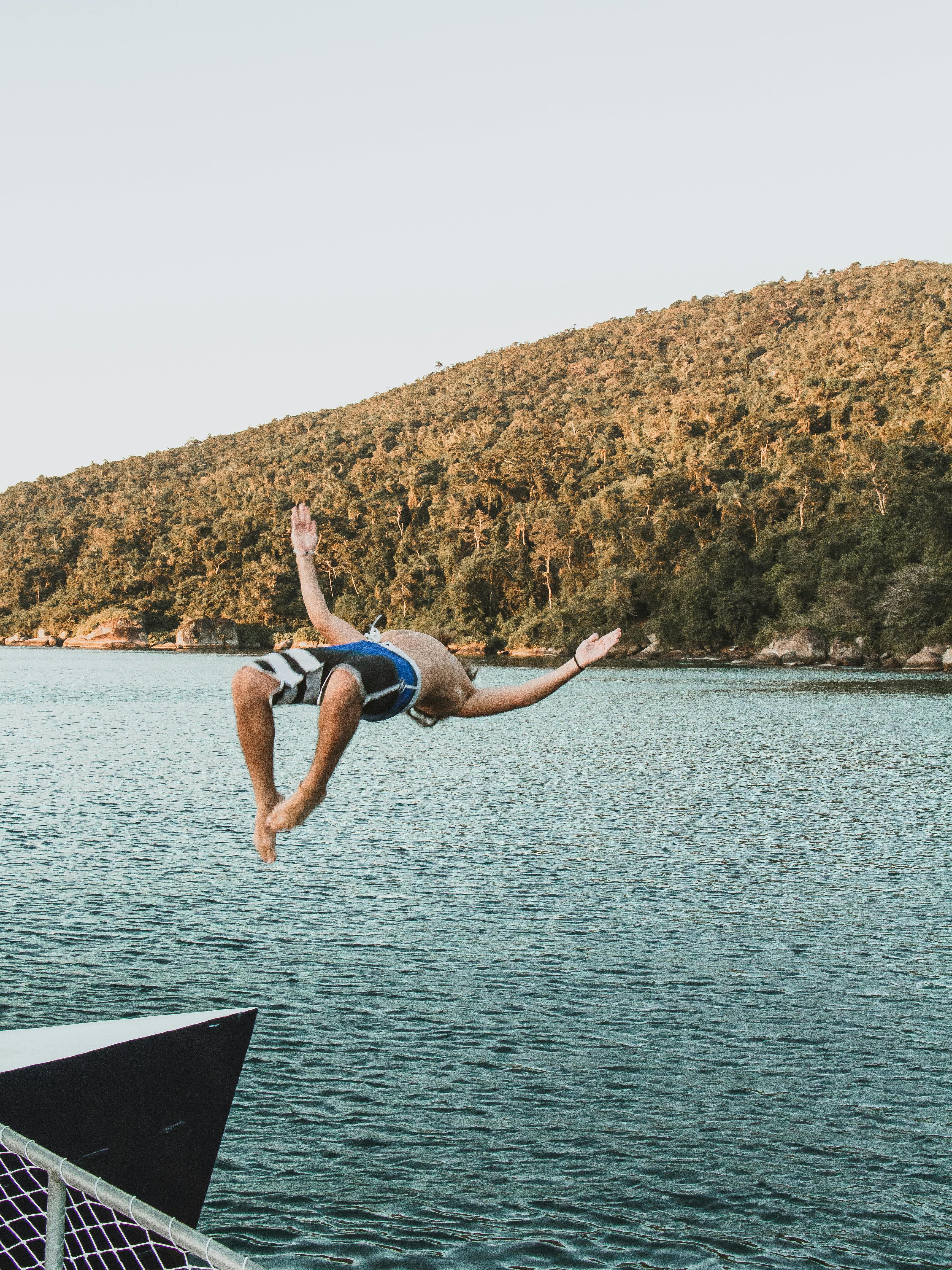 Photo of Man Diving on Lake · Free Stock Photo