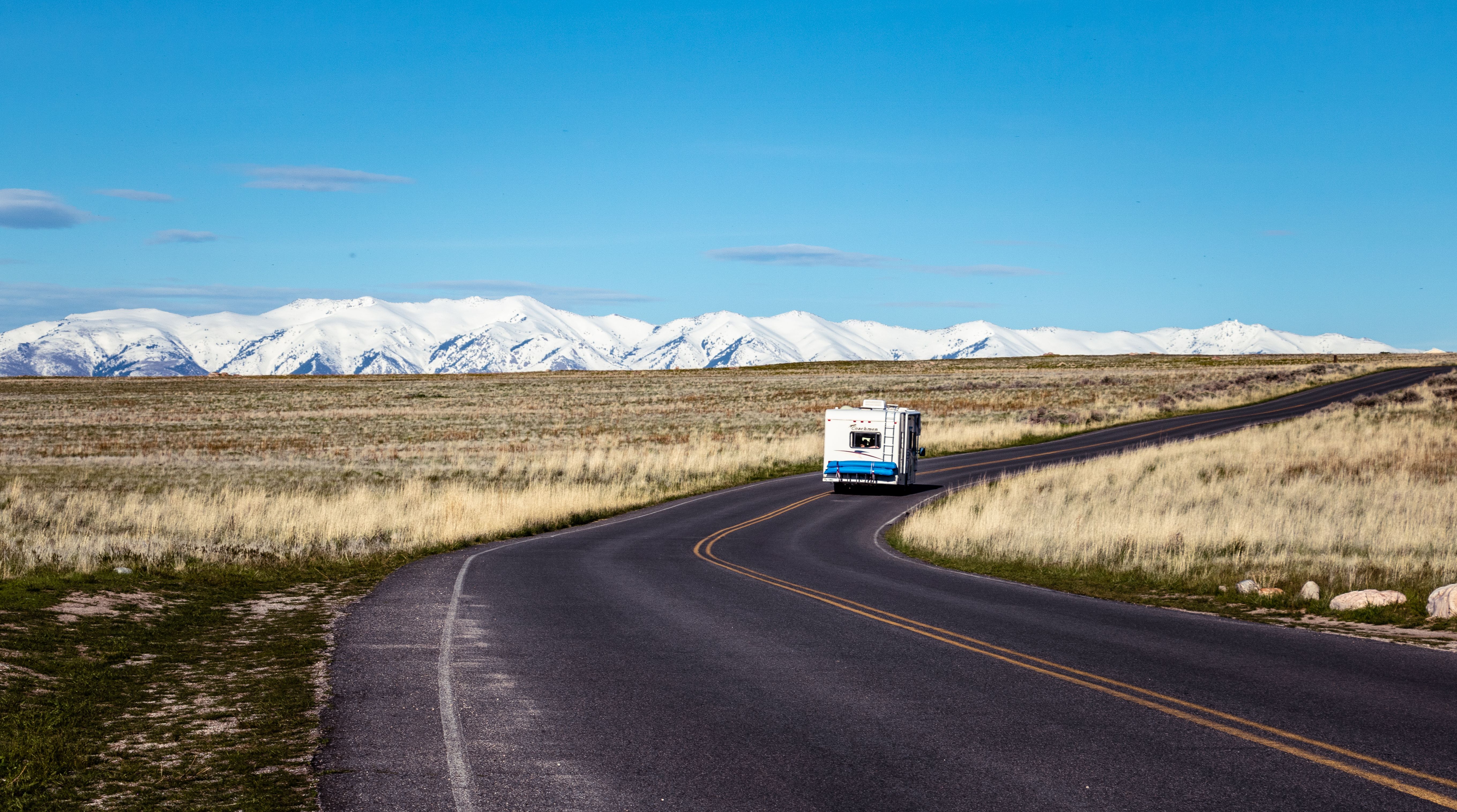White Vehicle Traveling on Road · Free Stock Photo
