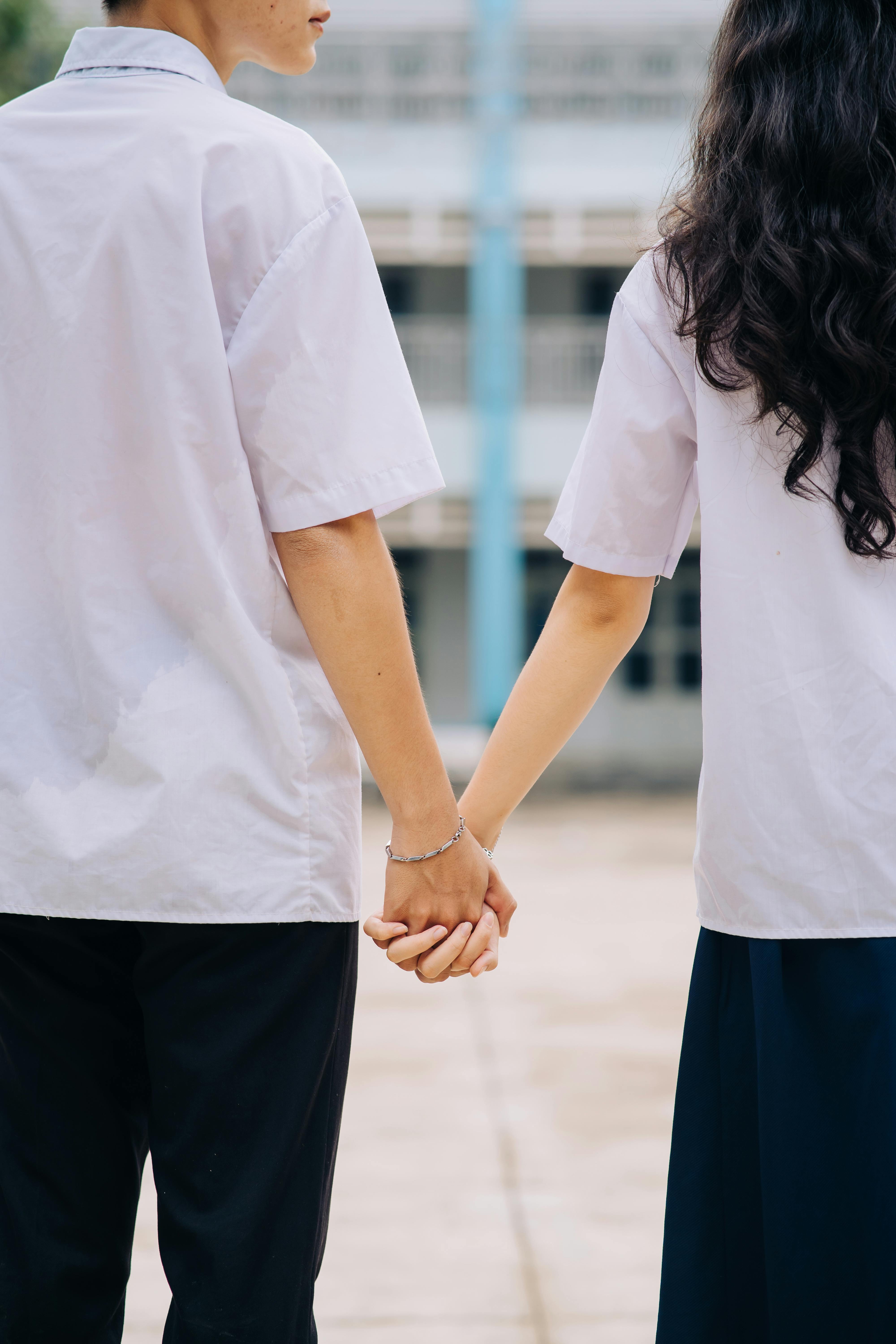 Back View of a Couple Holding Hands · Free Stock Photo