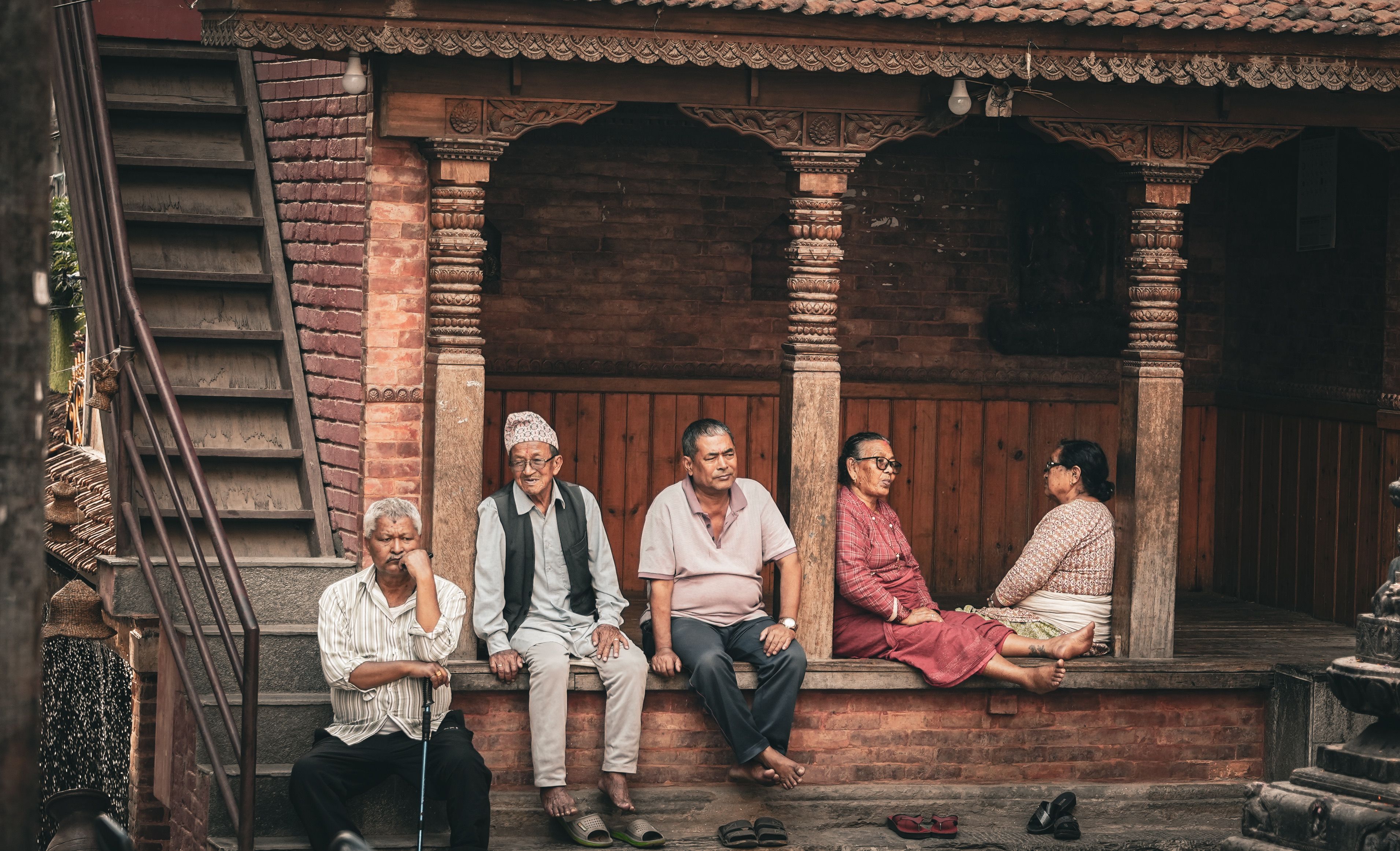 People sitting on steps outside a building · Free Stock Photo