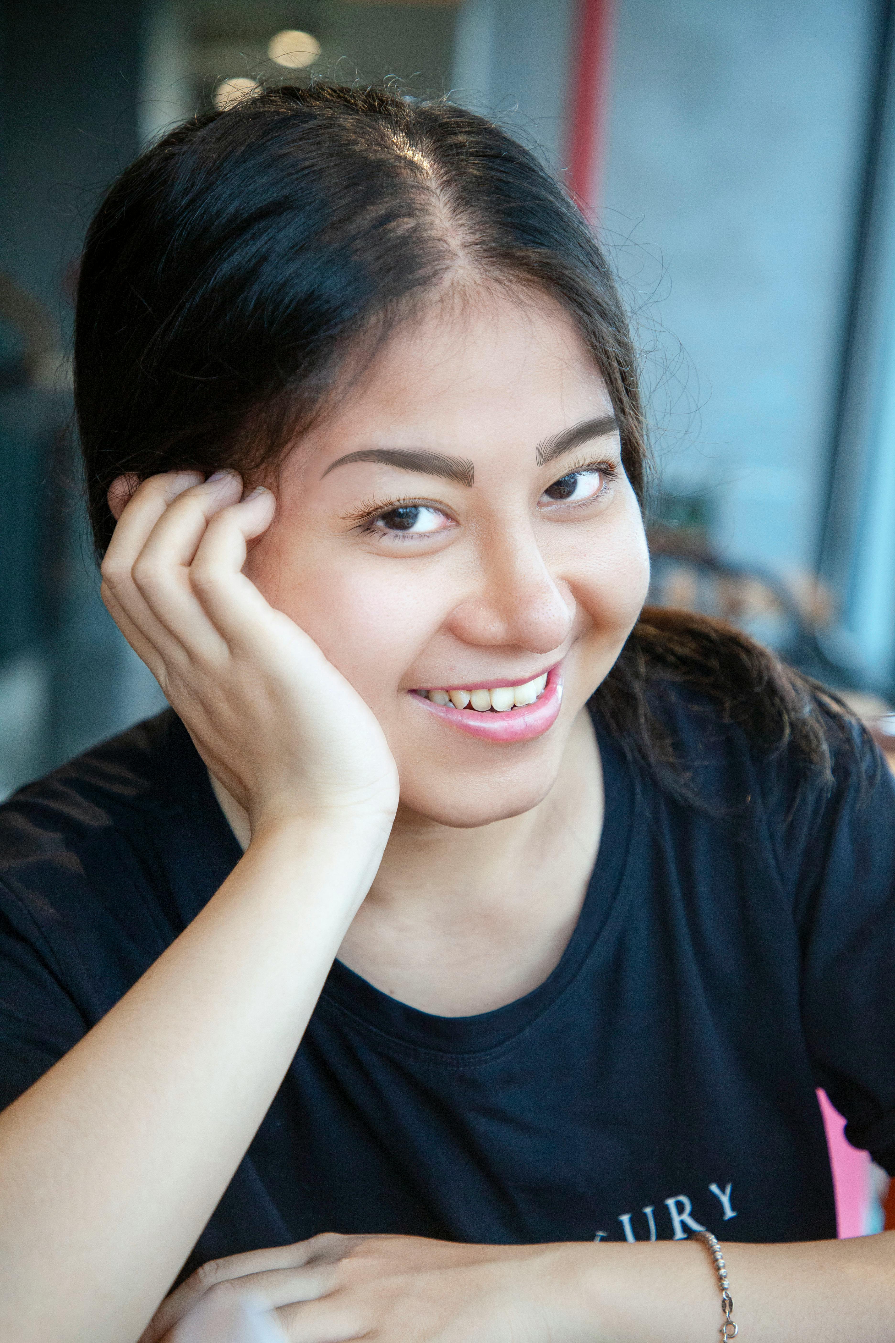 Smiling Woman Leaning Head on Hand · Free Stock Photo