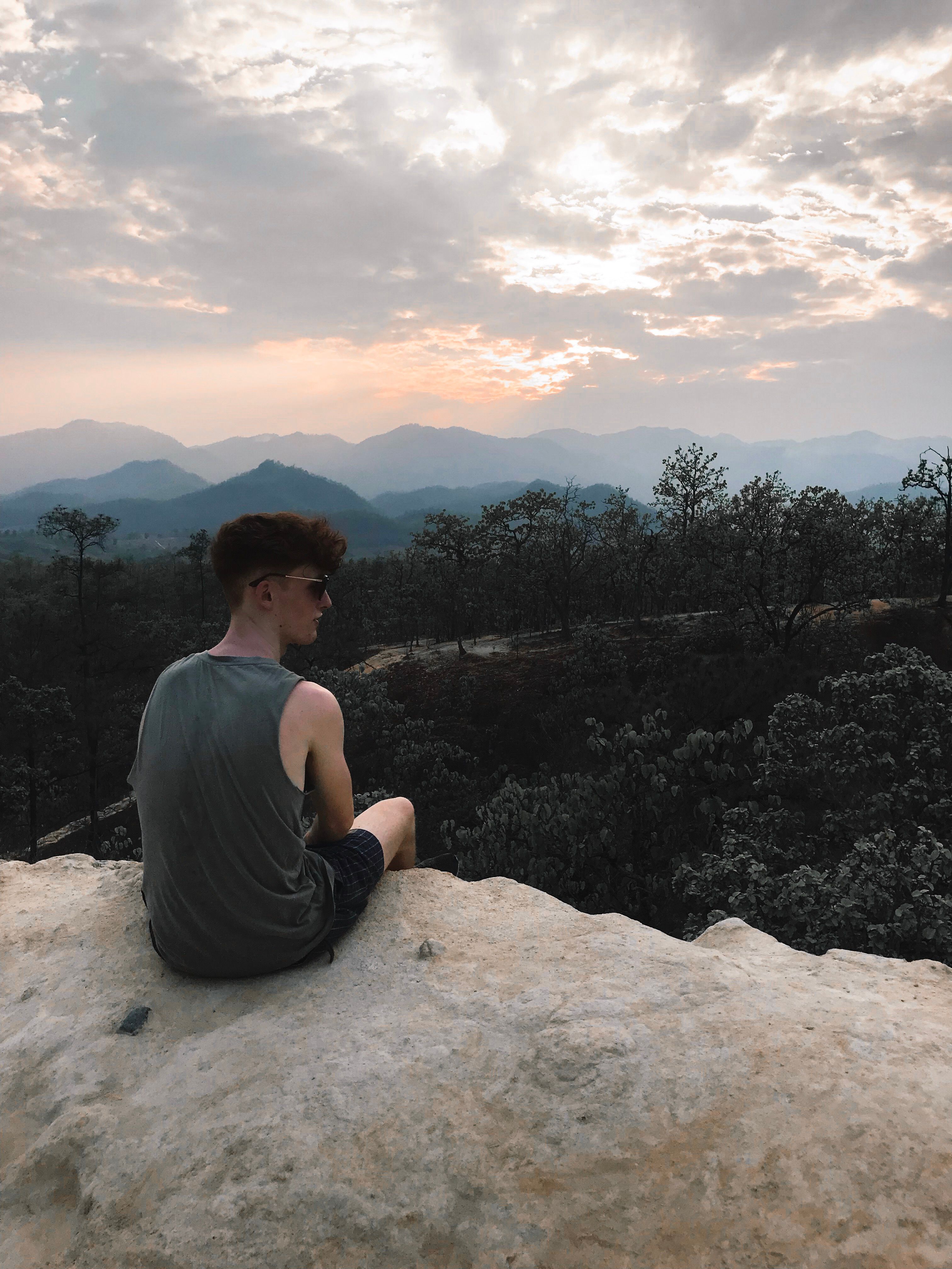 Man Sitting On Rock · Free Stock Photo