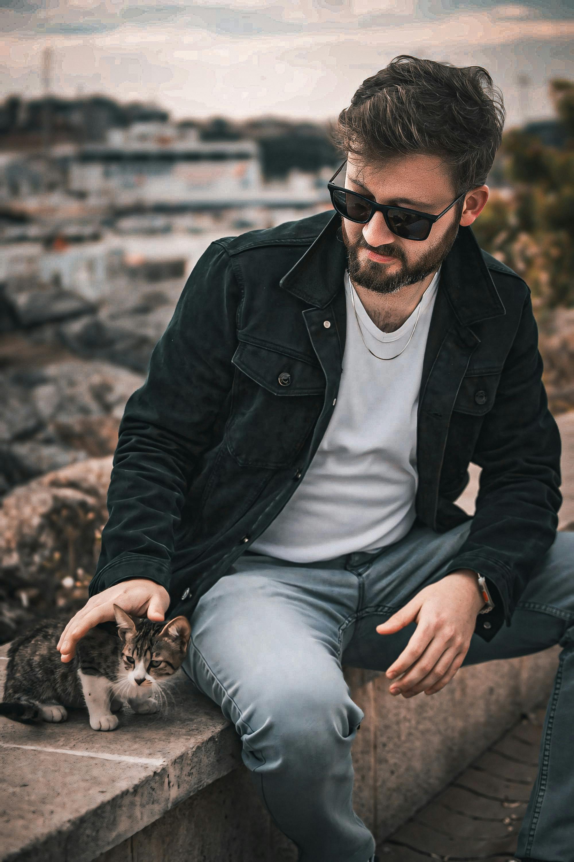 Sitting Man Patting Cat · Free Stock Photo