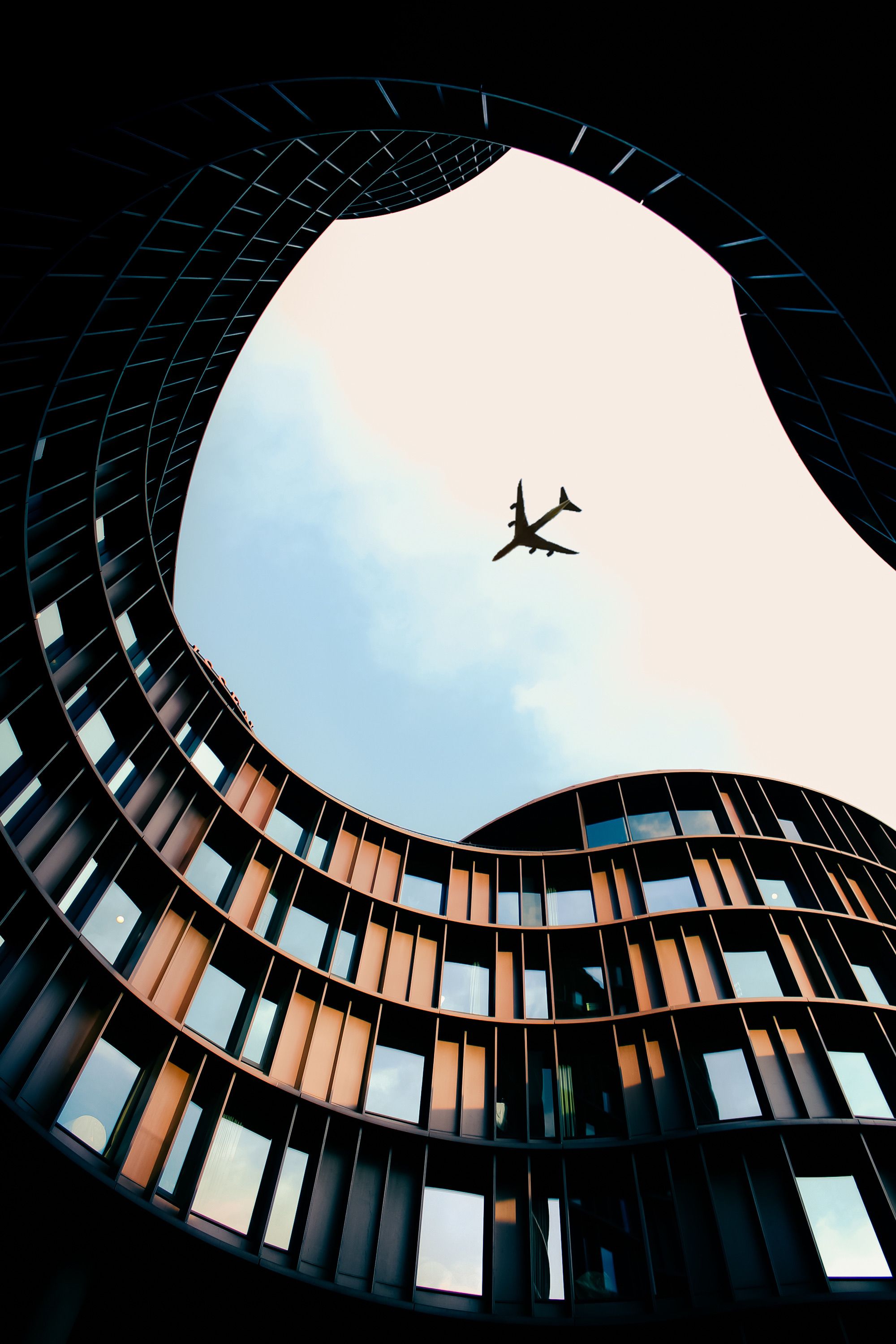 Airplane Flying over Residential Building in Copenhagen · Free Stock Photo