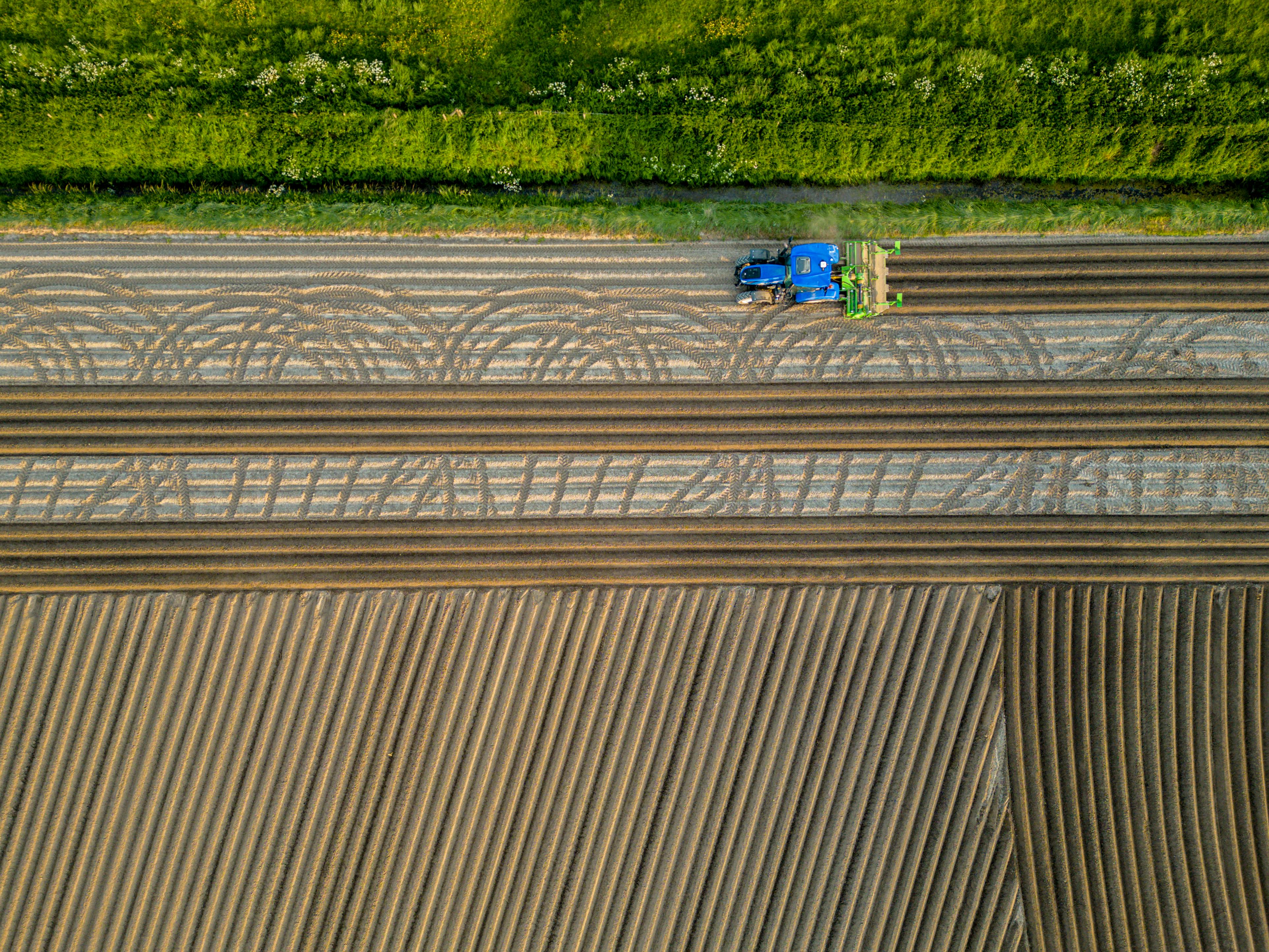 Drone Shot of Tractor Plowing Field · Free Stock Photo