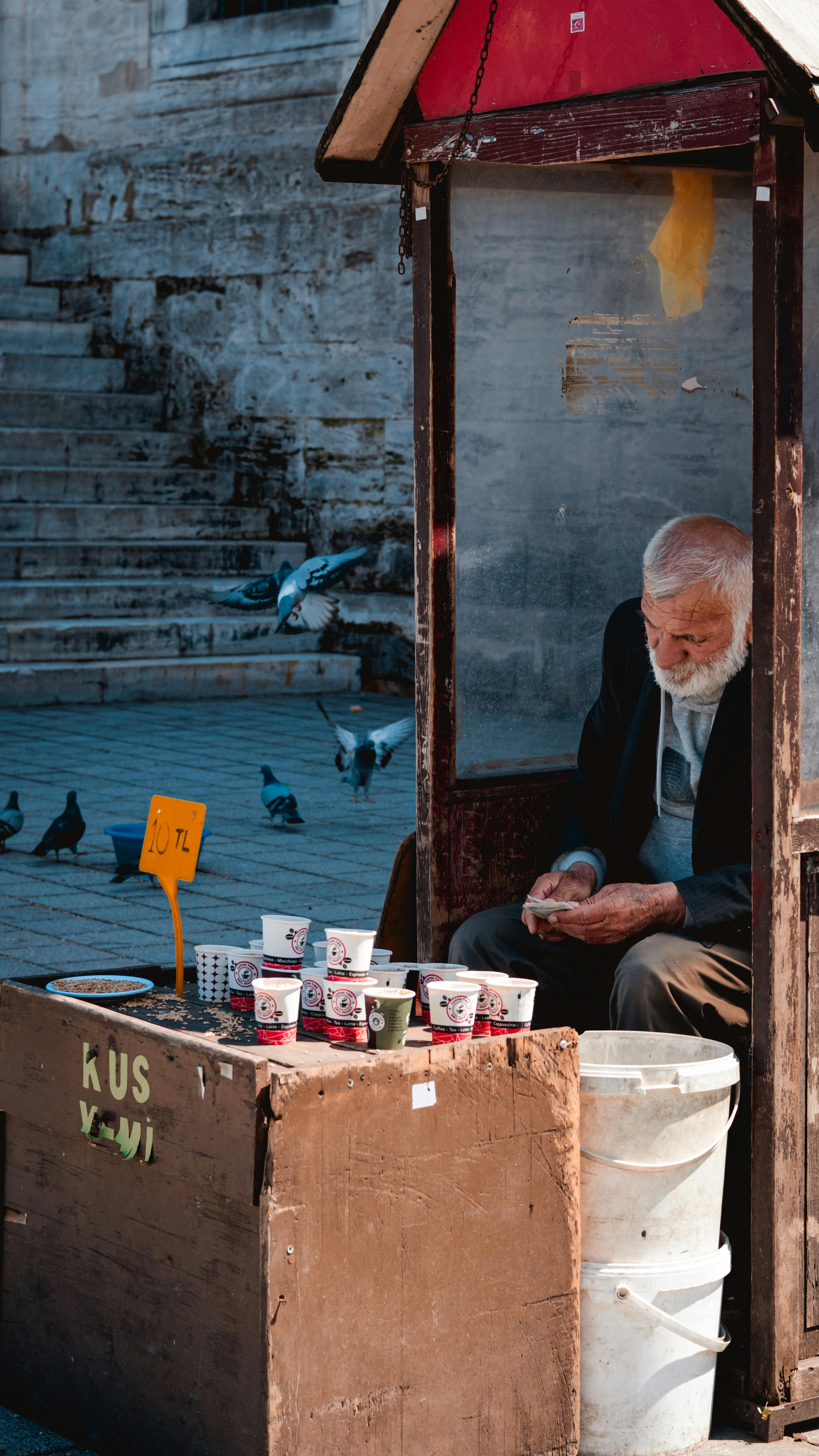 A Man on the Street Stall · Free Stock Photo