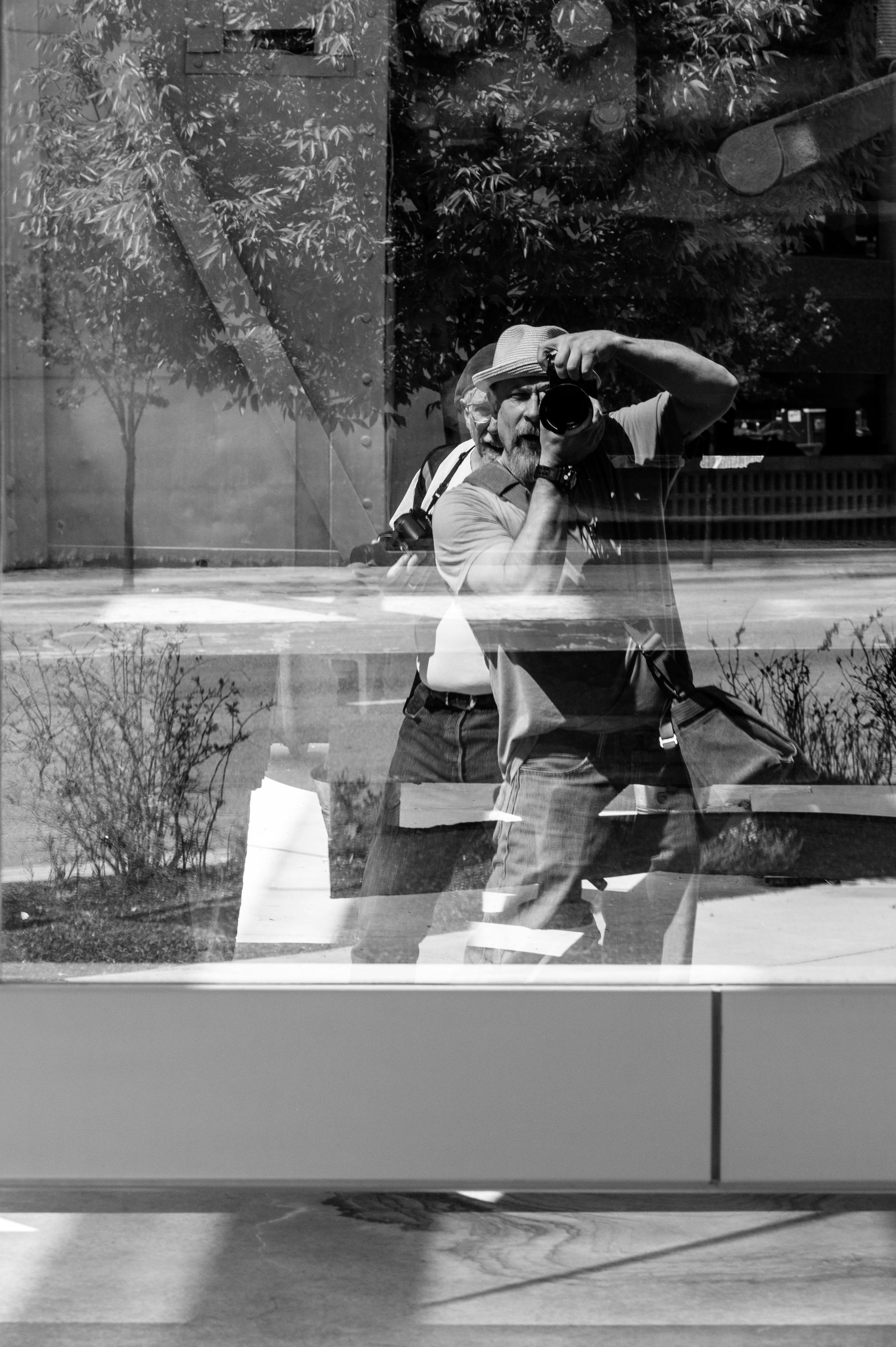 Elderly Men with Cameras on Reflection on Window · Free Stock Photo