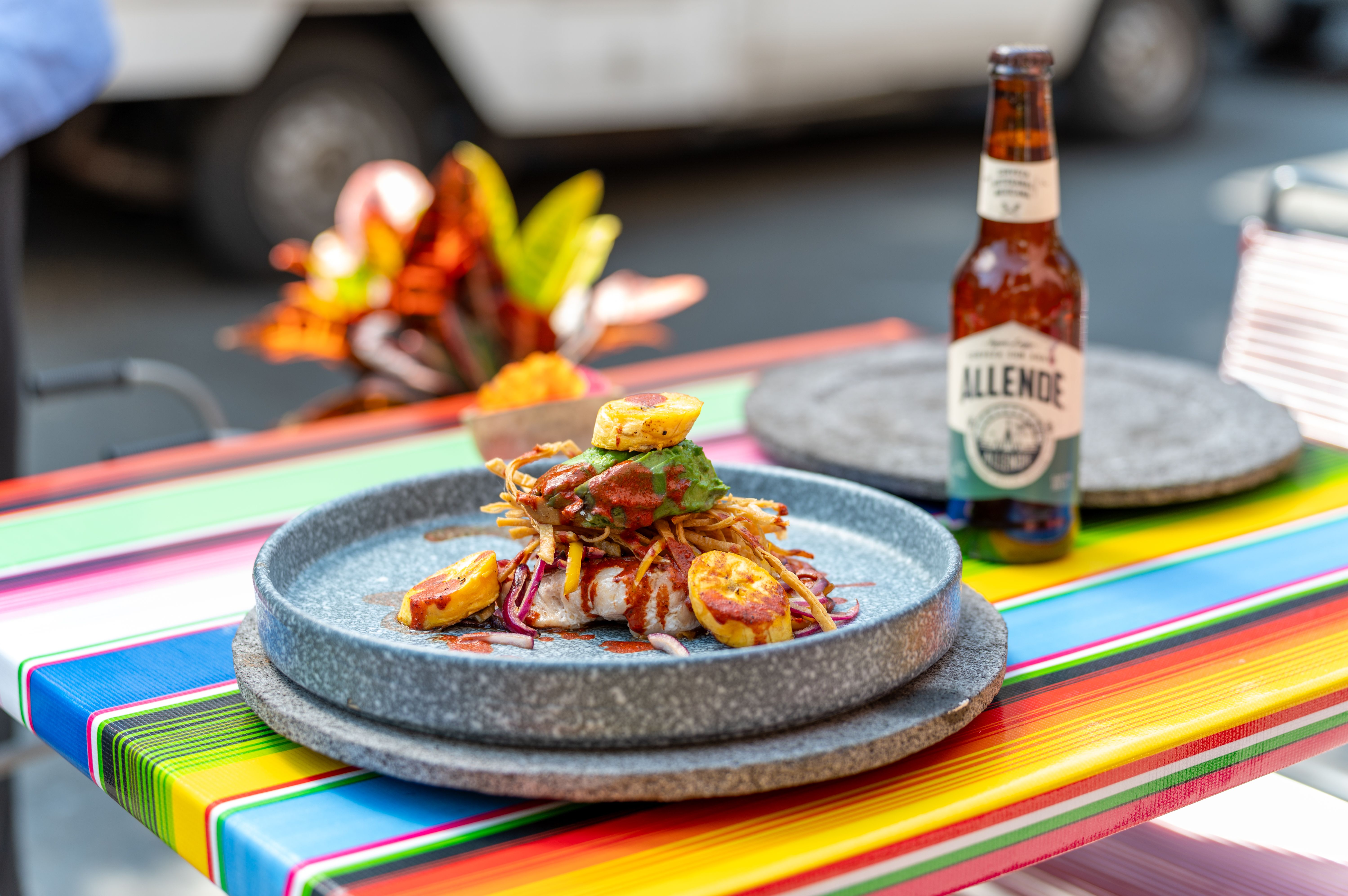 Dish on Gray Plate Next to Bottle of Beer on Table · Free Stock Photo