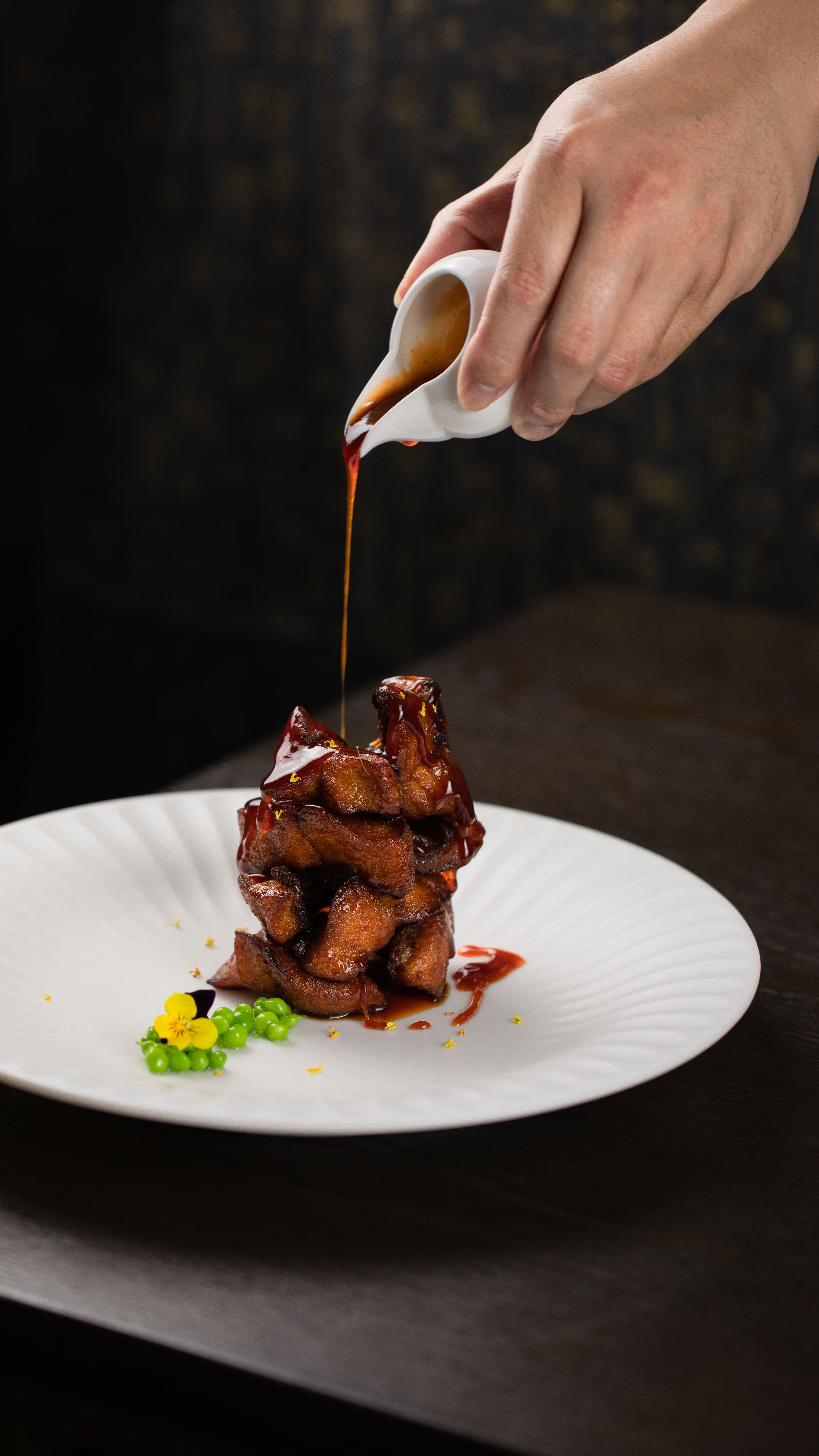 Pouring Sauce on Beef on Plate · Free Stock Photo
