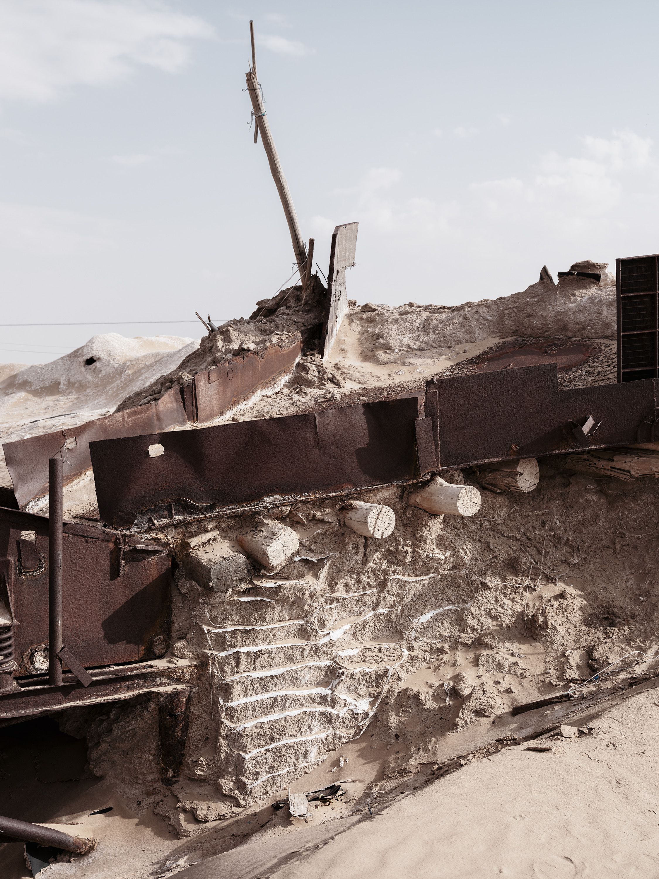 Makeshift Metal Barriers in Sand Wasteland · Free Stock Photo