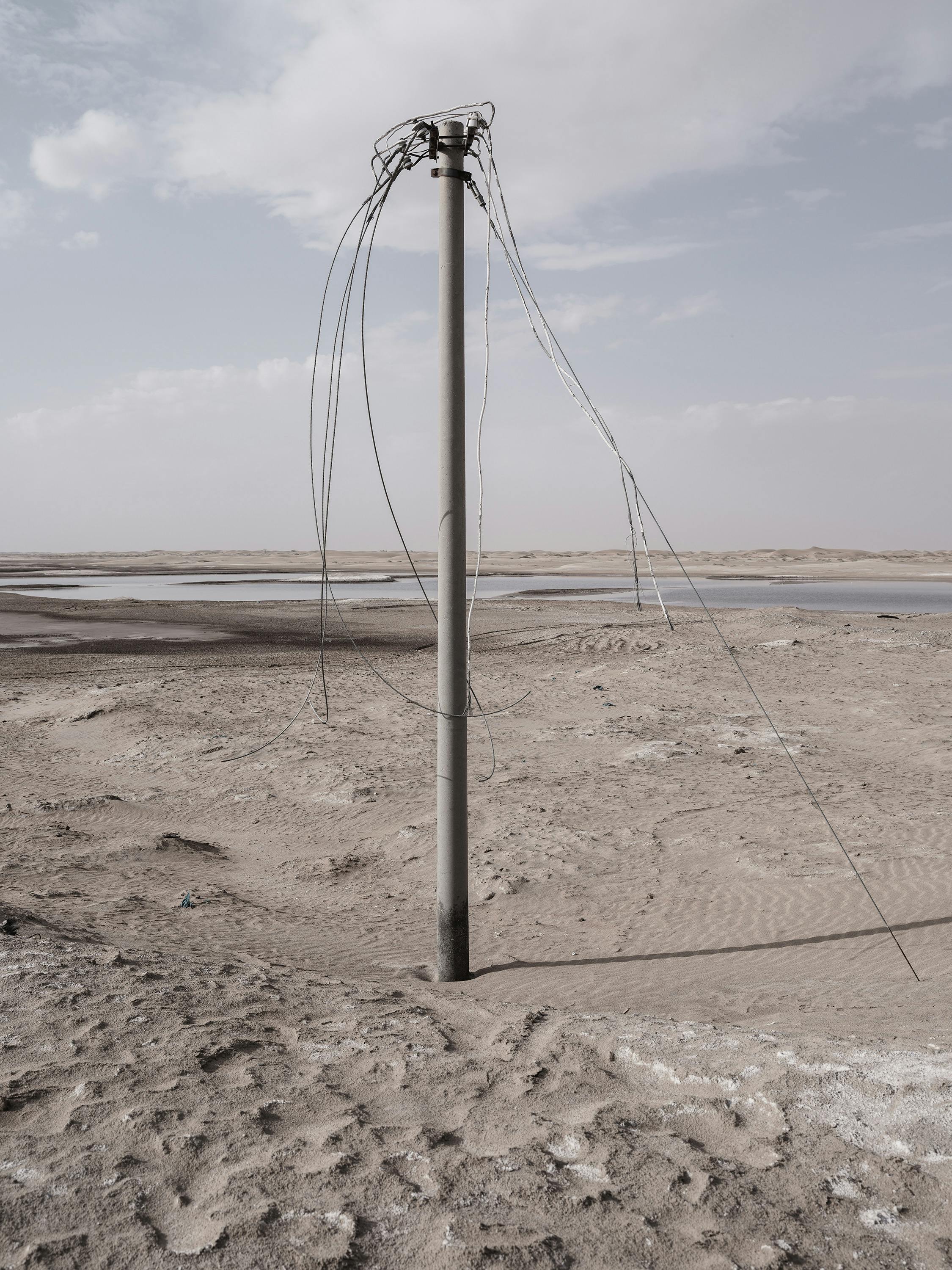 Utility Pole with Snapped Wires on Beach · Free Stock Photo