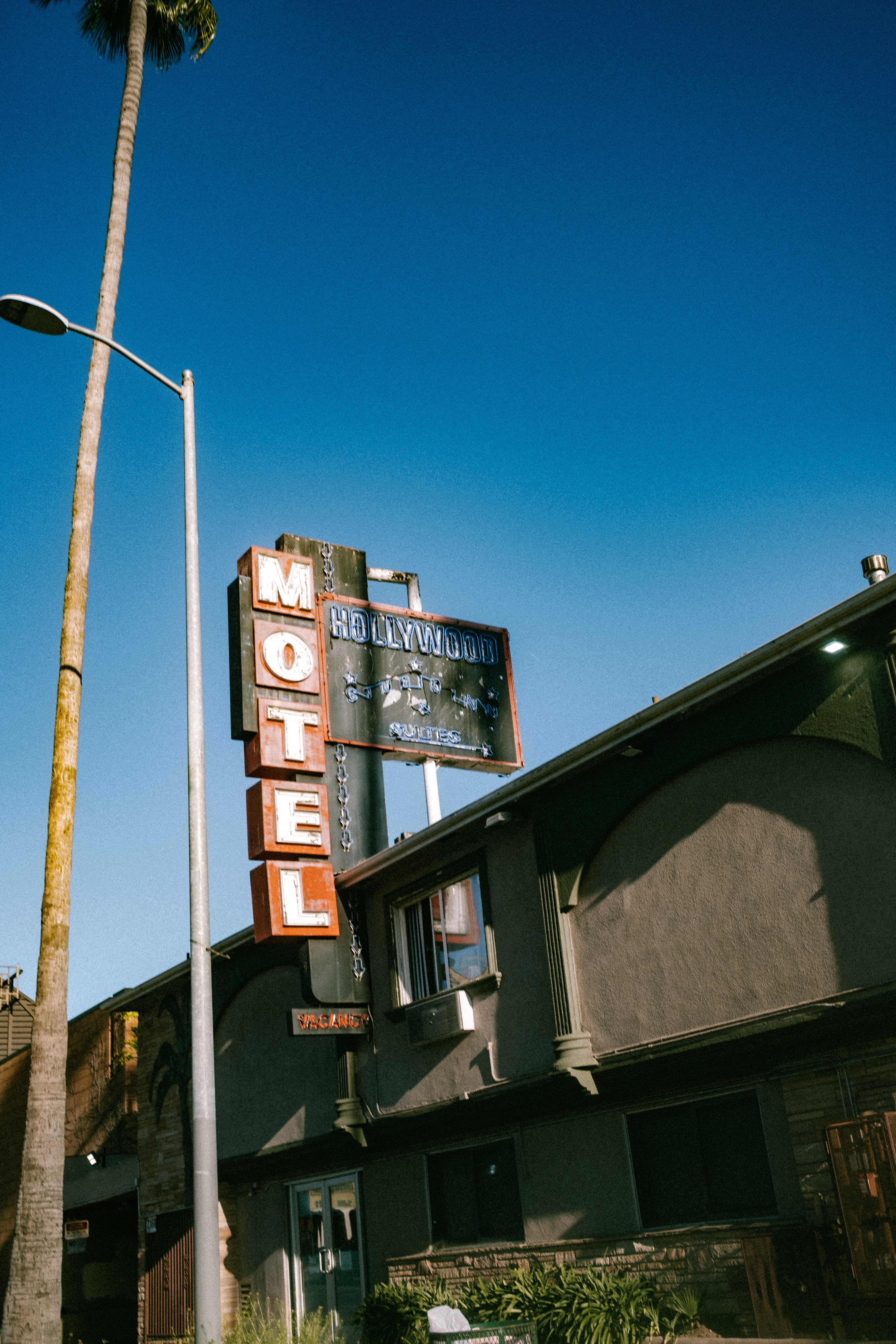 An Old Motel Sign under a Clear, Blue Sky · Free Stock Photo