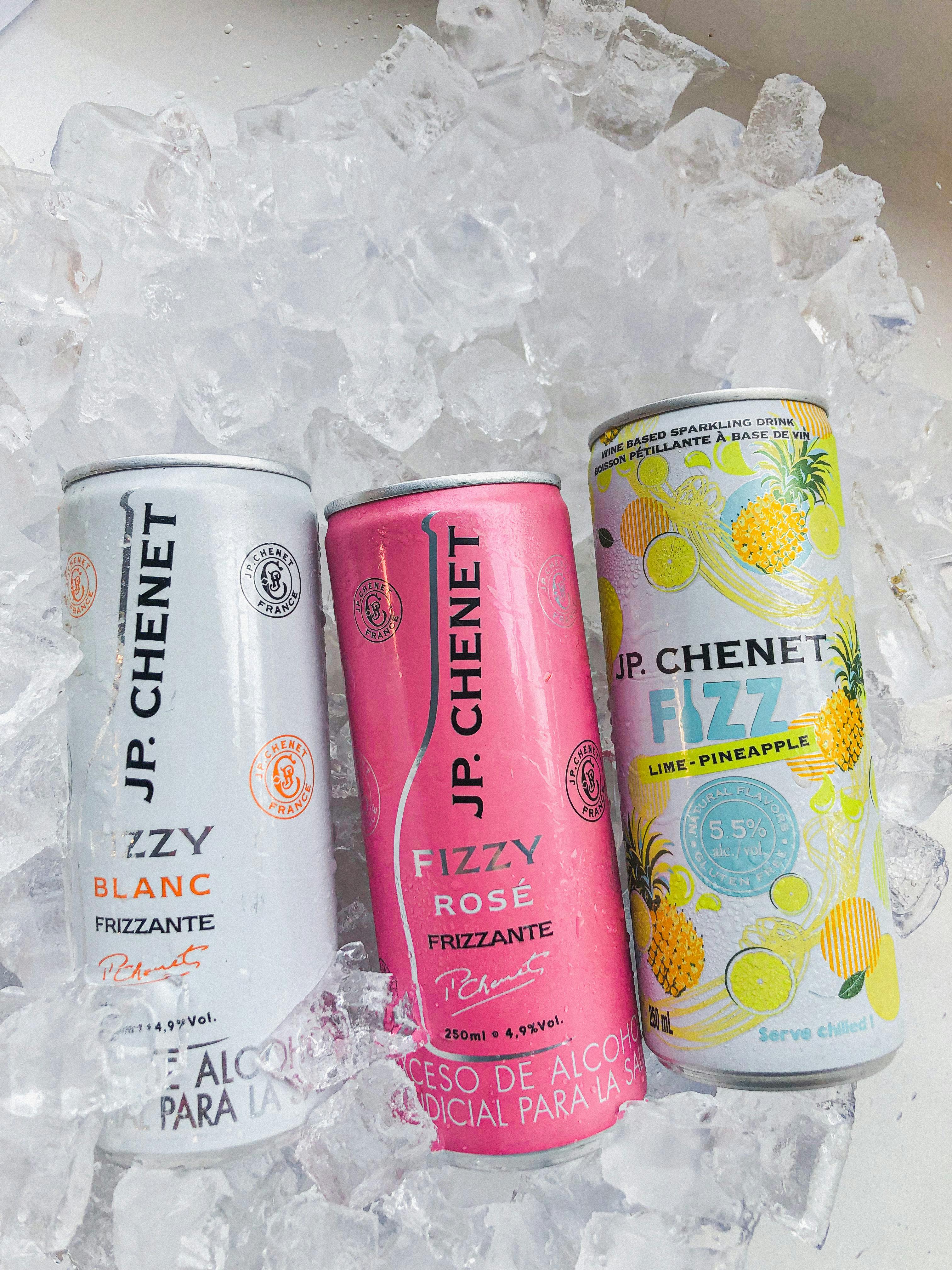 Cans of JP Chenet Fizzy Drinks Lying in Ice · Free Stock Photo