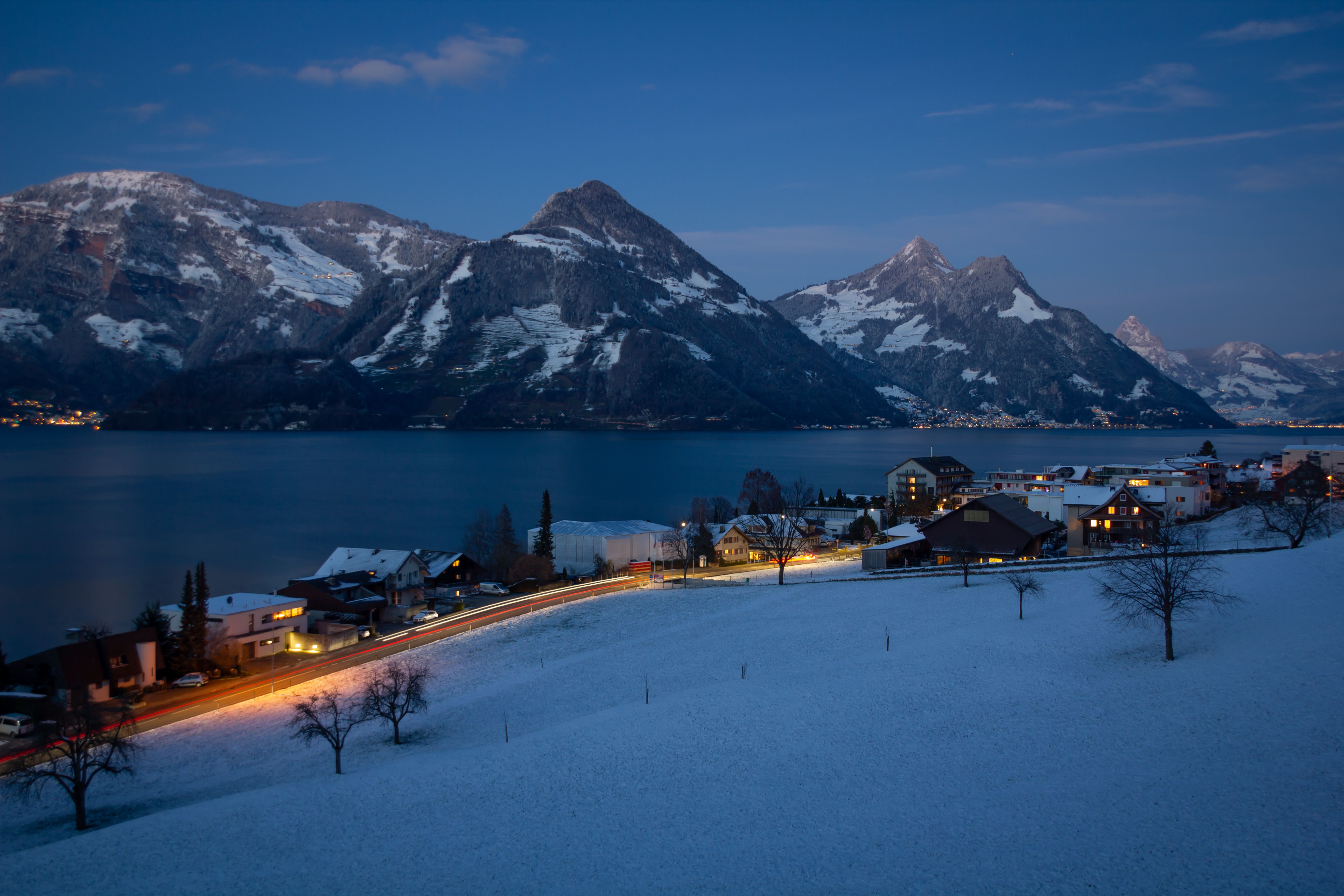 View of Houses along the Lake Lucerne and Mountains in the Background ...