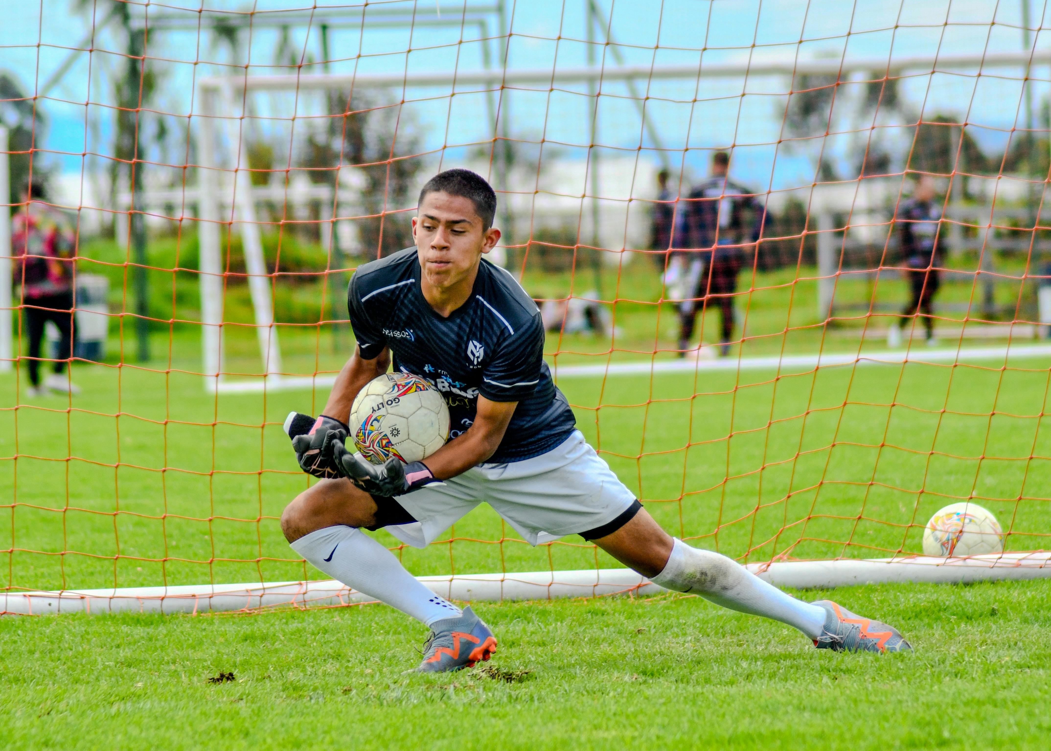 Goalkeeper Catching a Soccer Ball · Free Stock Photo
