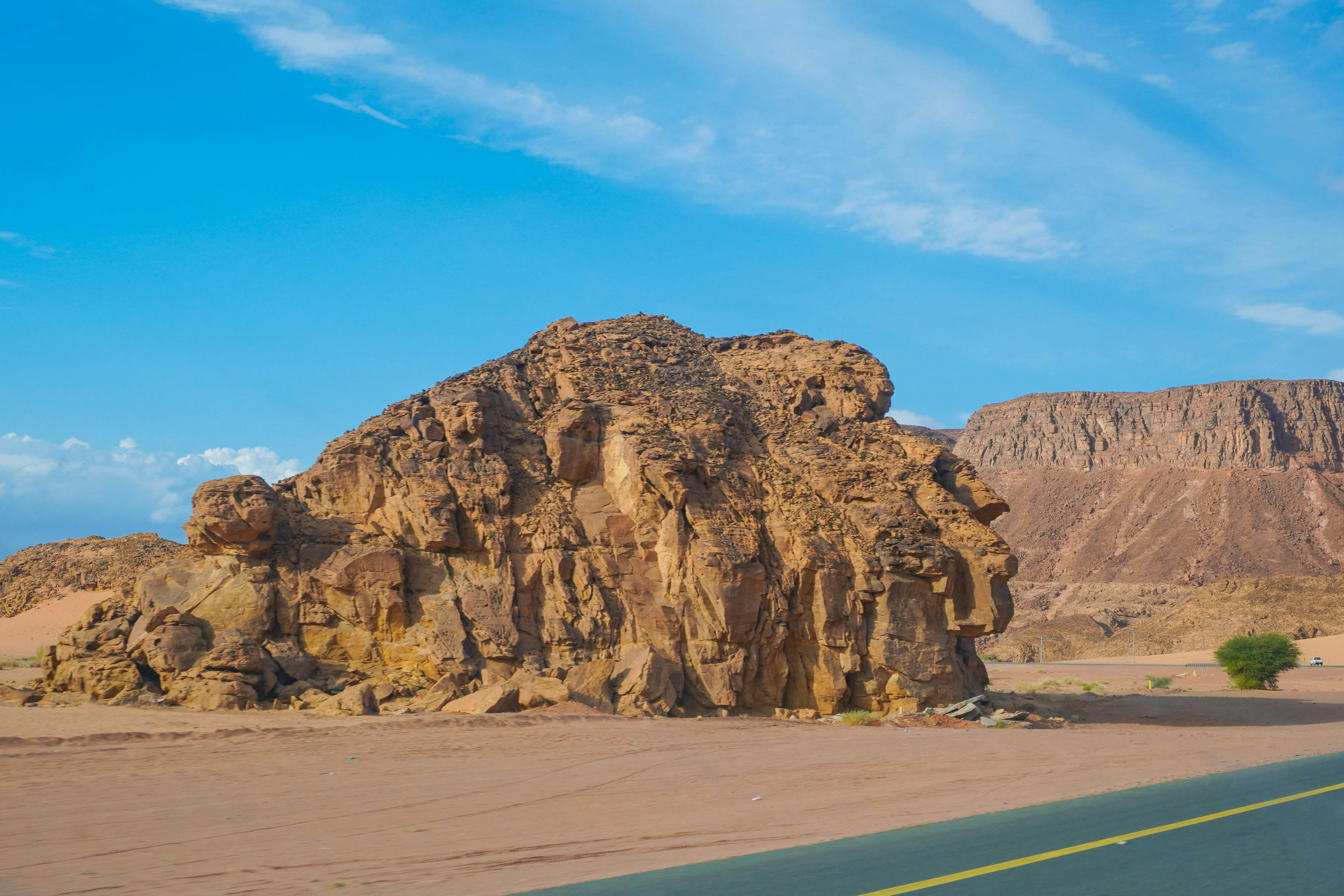 Rugged Rock on the Side of the Road Through the Desert · Free Stock Photo