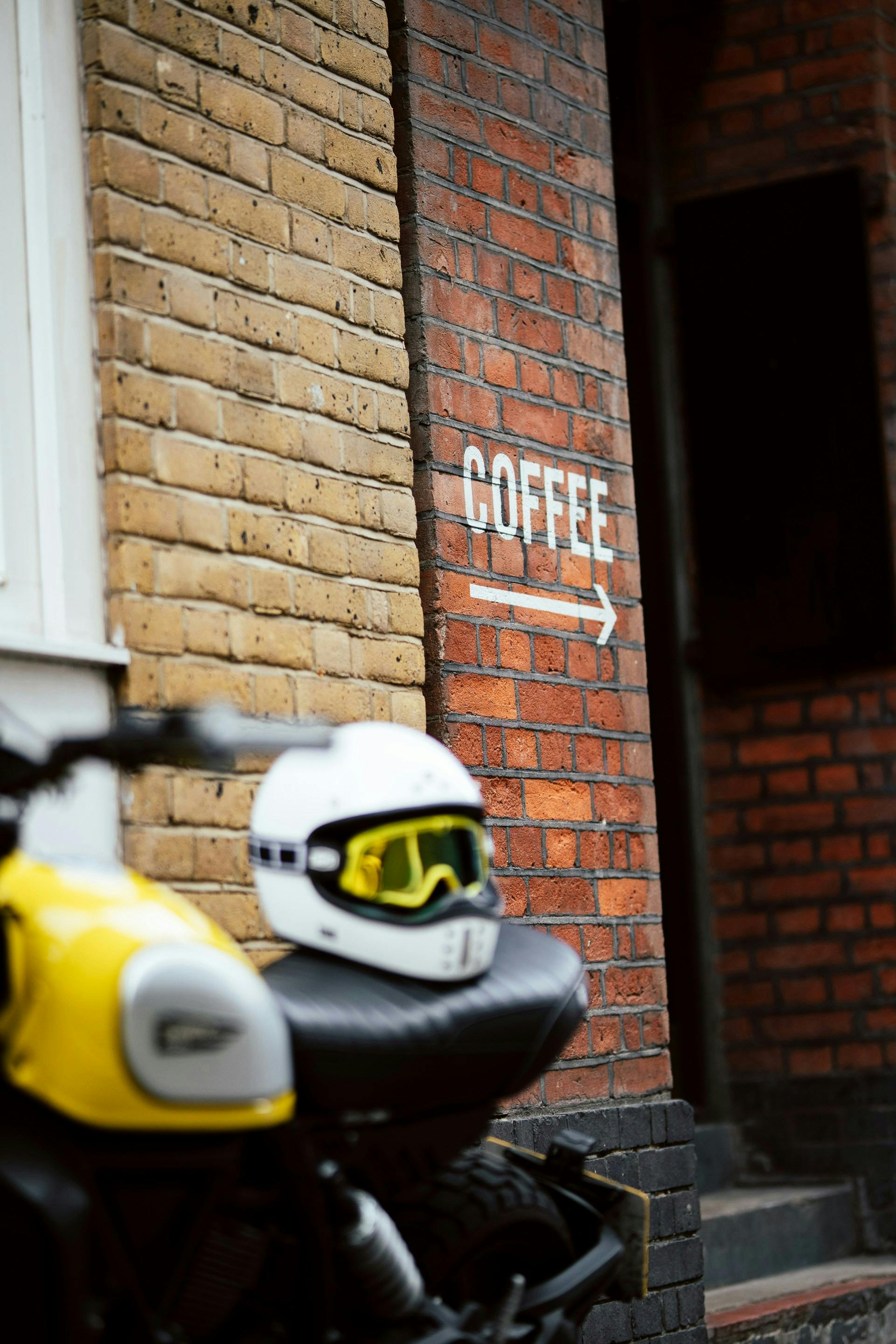 Directional Arrow on a Brick Wall with a Motorcycle Standing in the ...