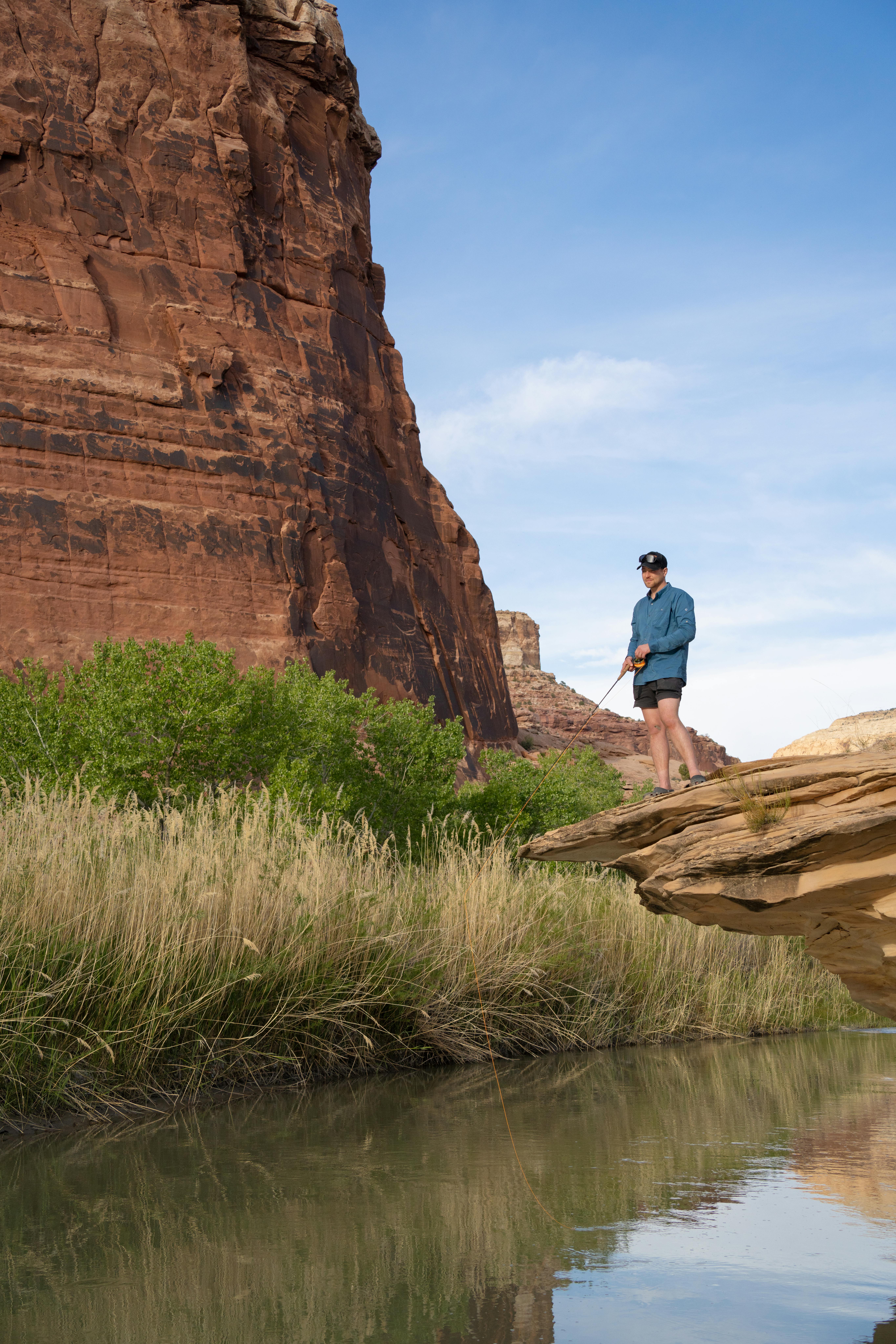 Man Fishing from an Outcrop · Free Stock Photo