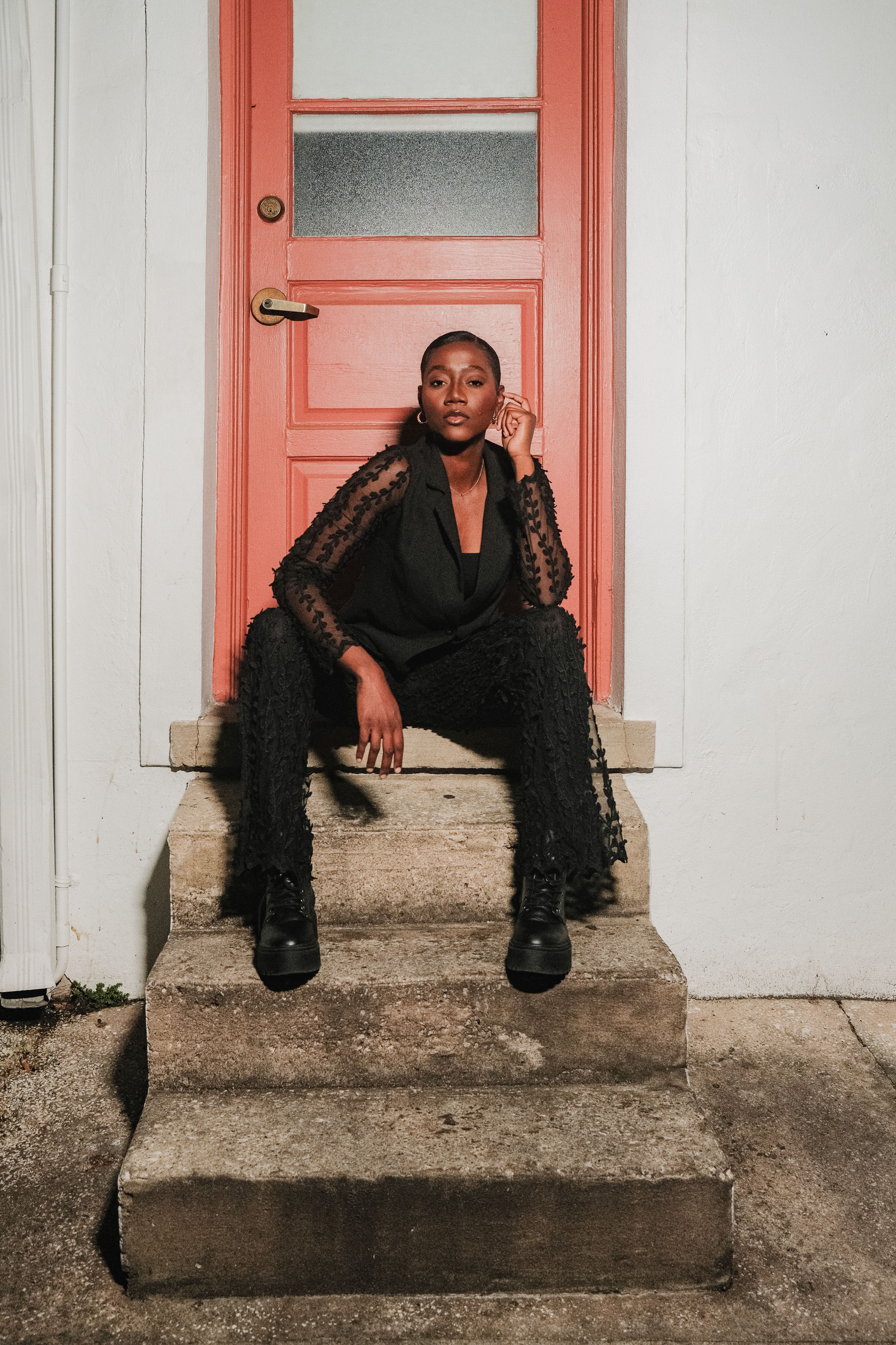 A Fashionable Woman Sitting on Steps by the Front Door · Free Stock Photo
