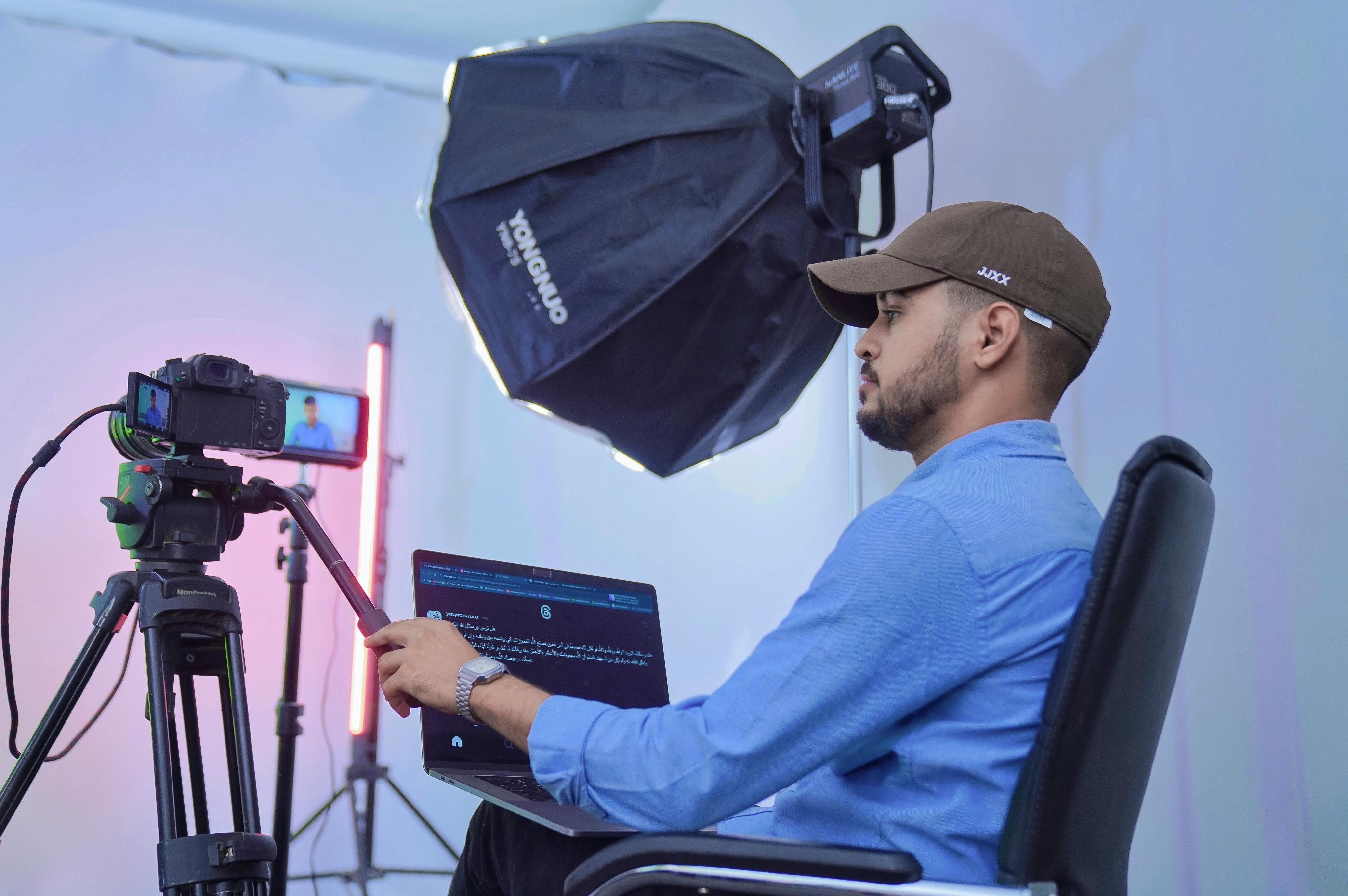 Photo of a Man Operating a Camera in a Studio · Free Stock Photo