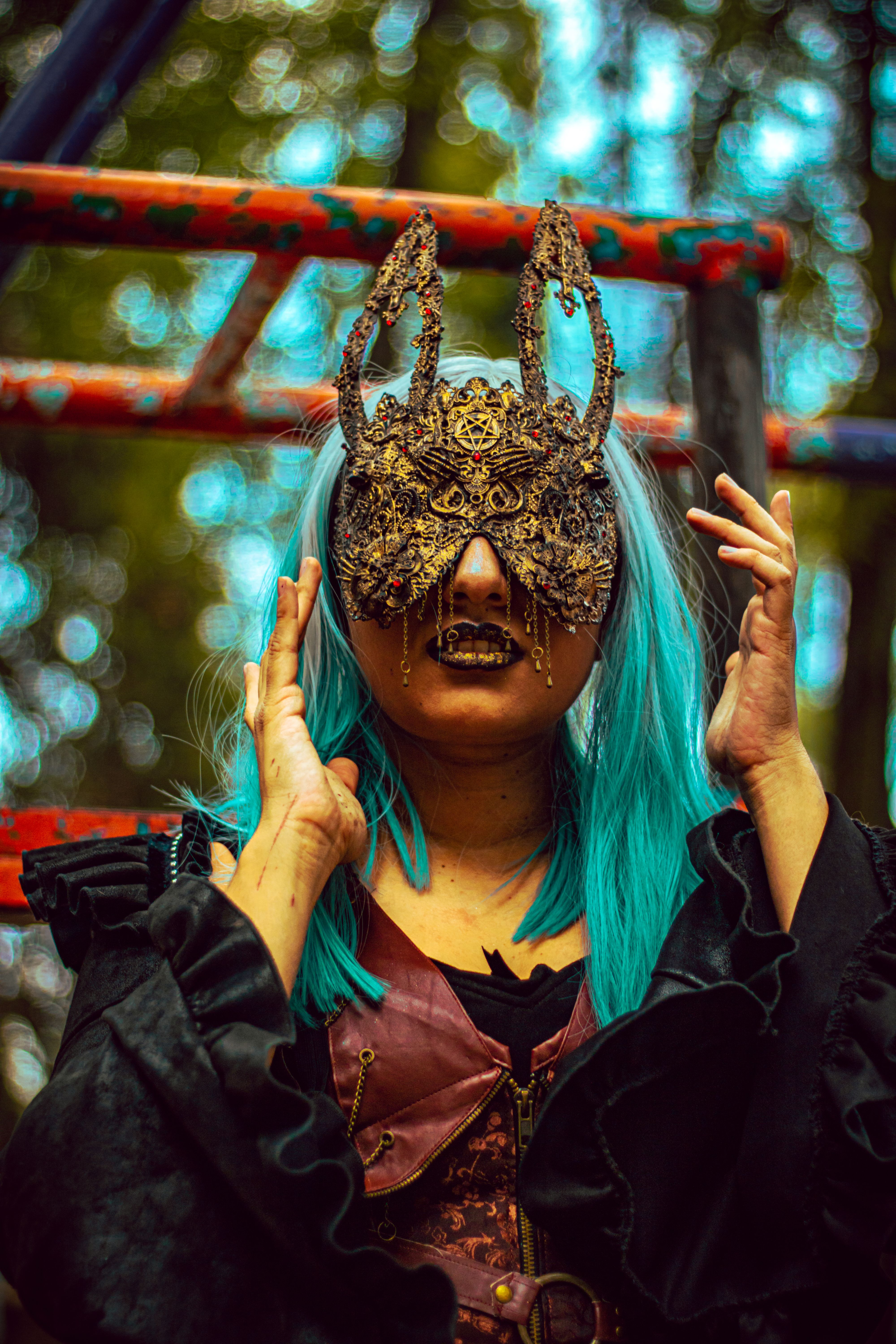 A woman with blue hair and a mask on her head · Free Stock Photo