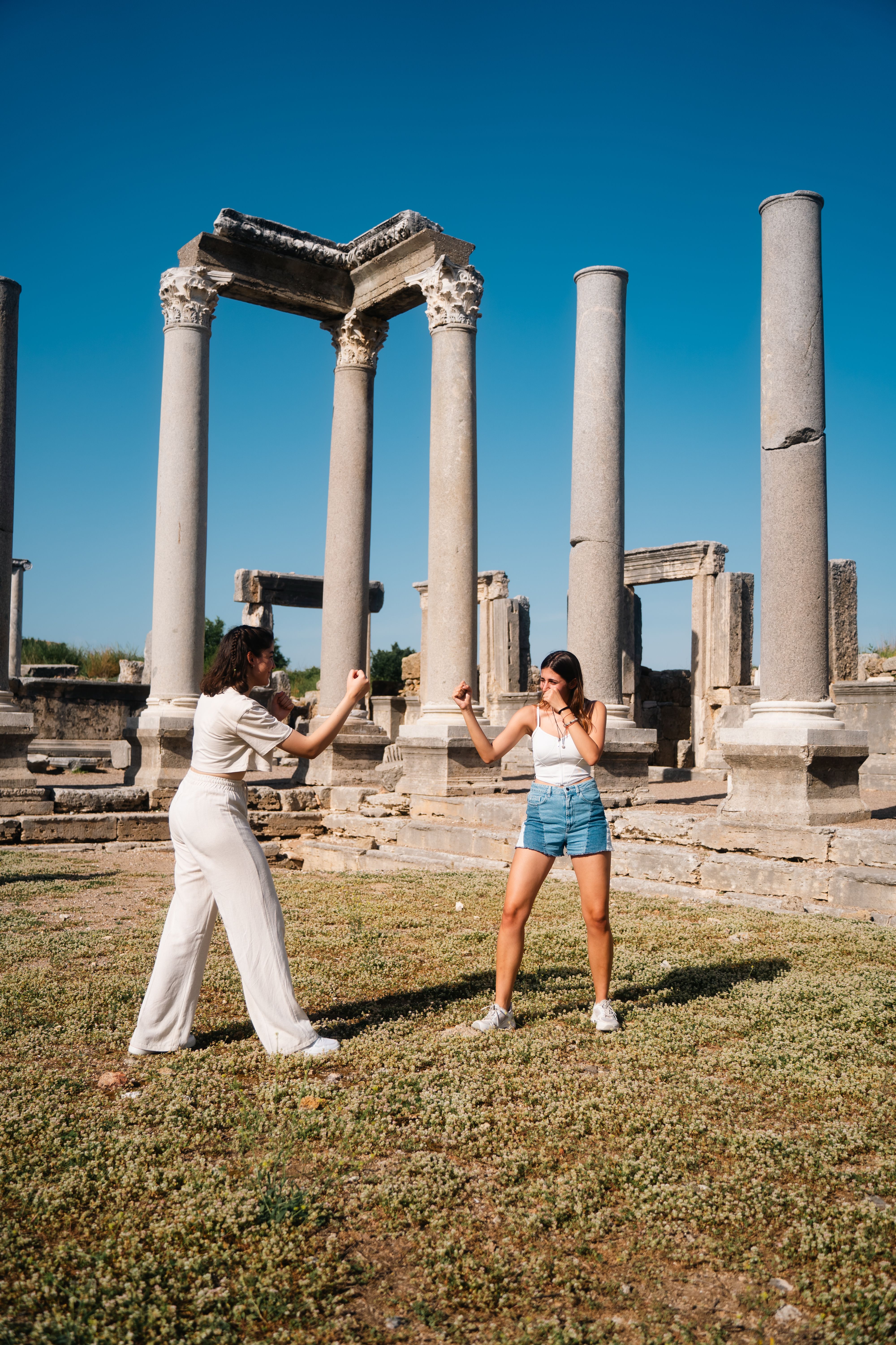 Young Friends Exploring Ancient Ruins on Sunny Day · Free Stock Photo