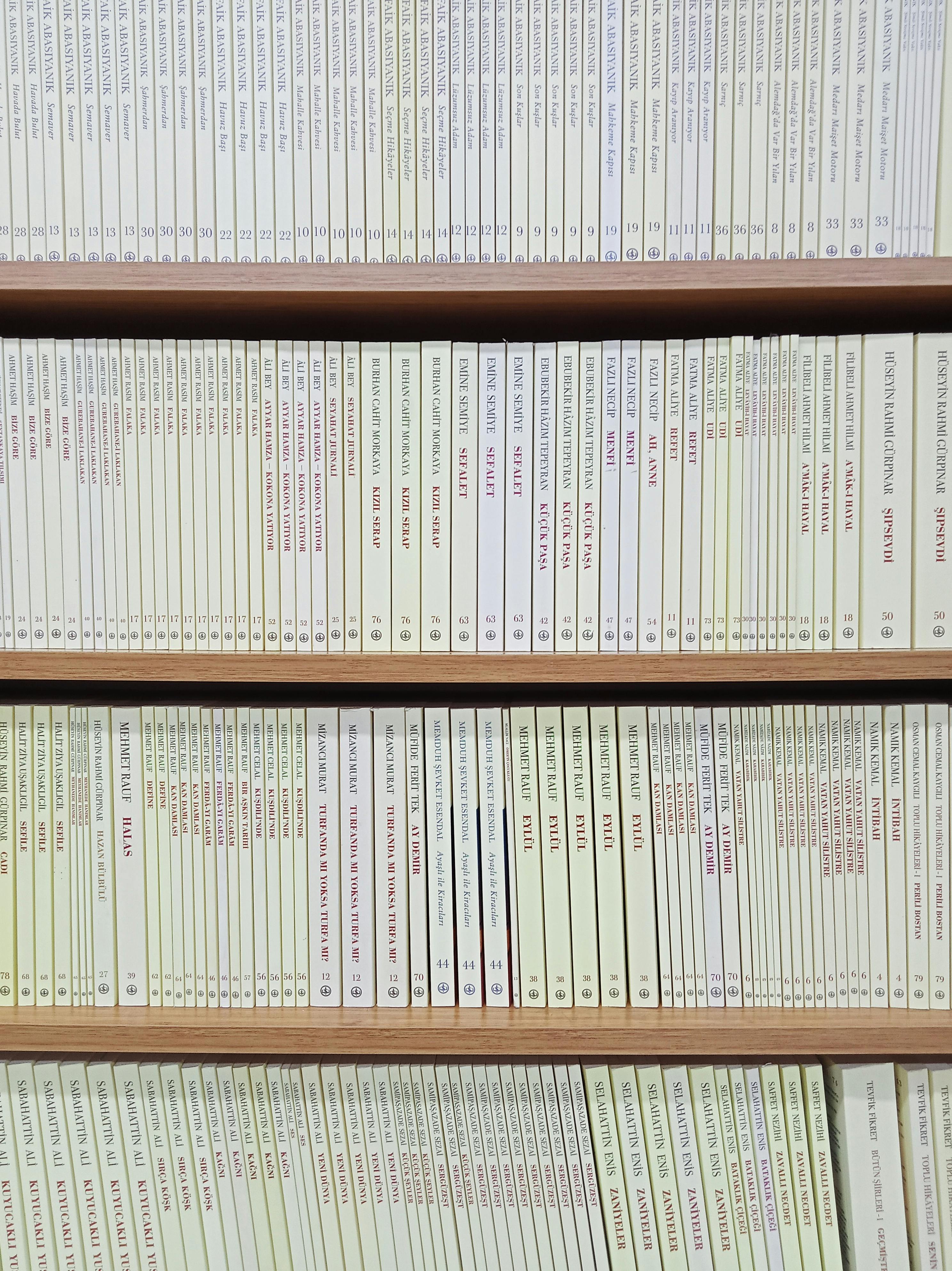 Collection of White Books on a Bookshelf · Free Stock Photo