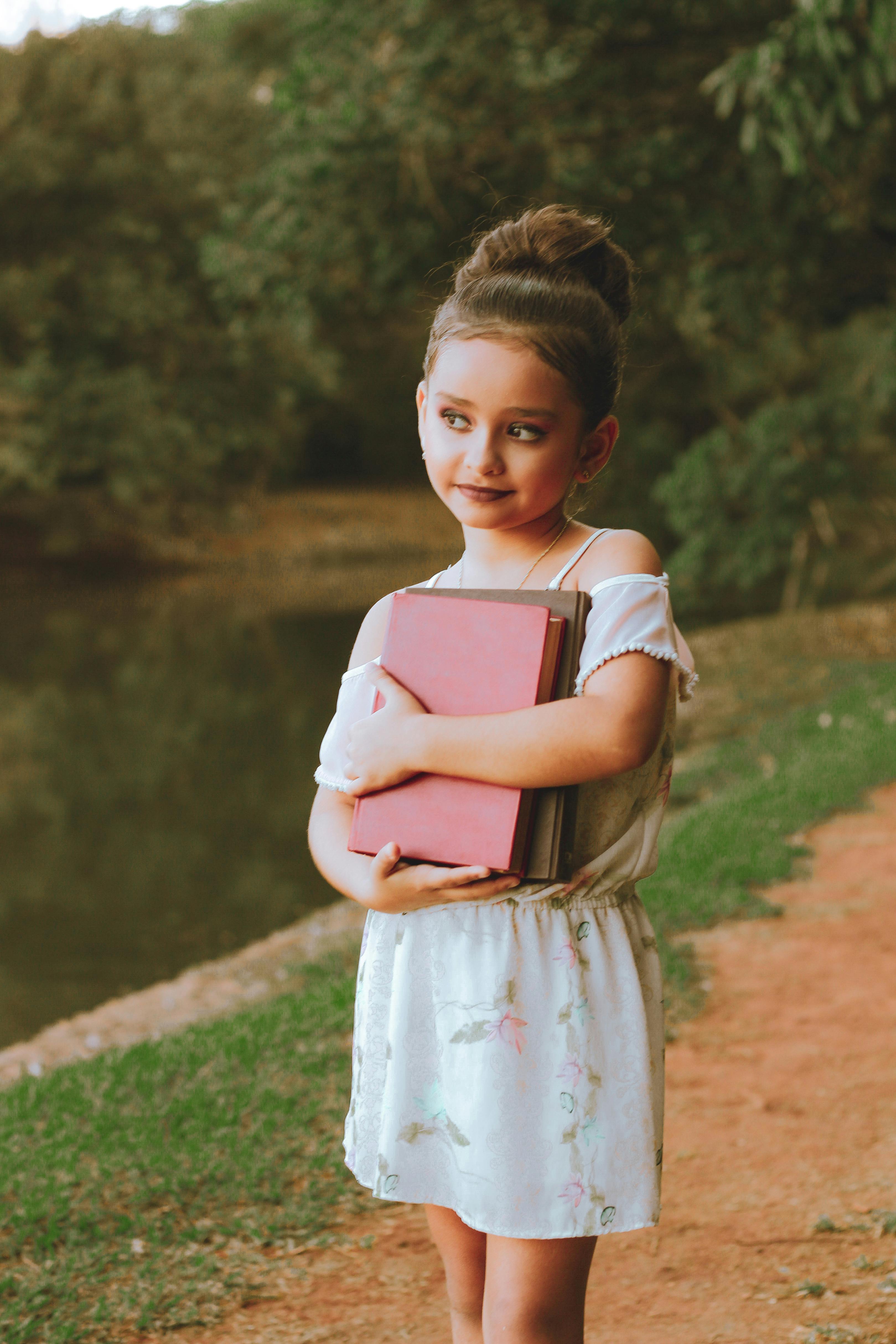 Girl Carrying Books · Free Stock Photo