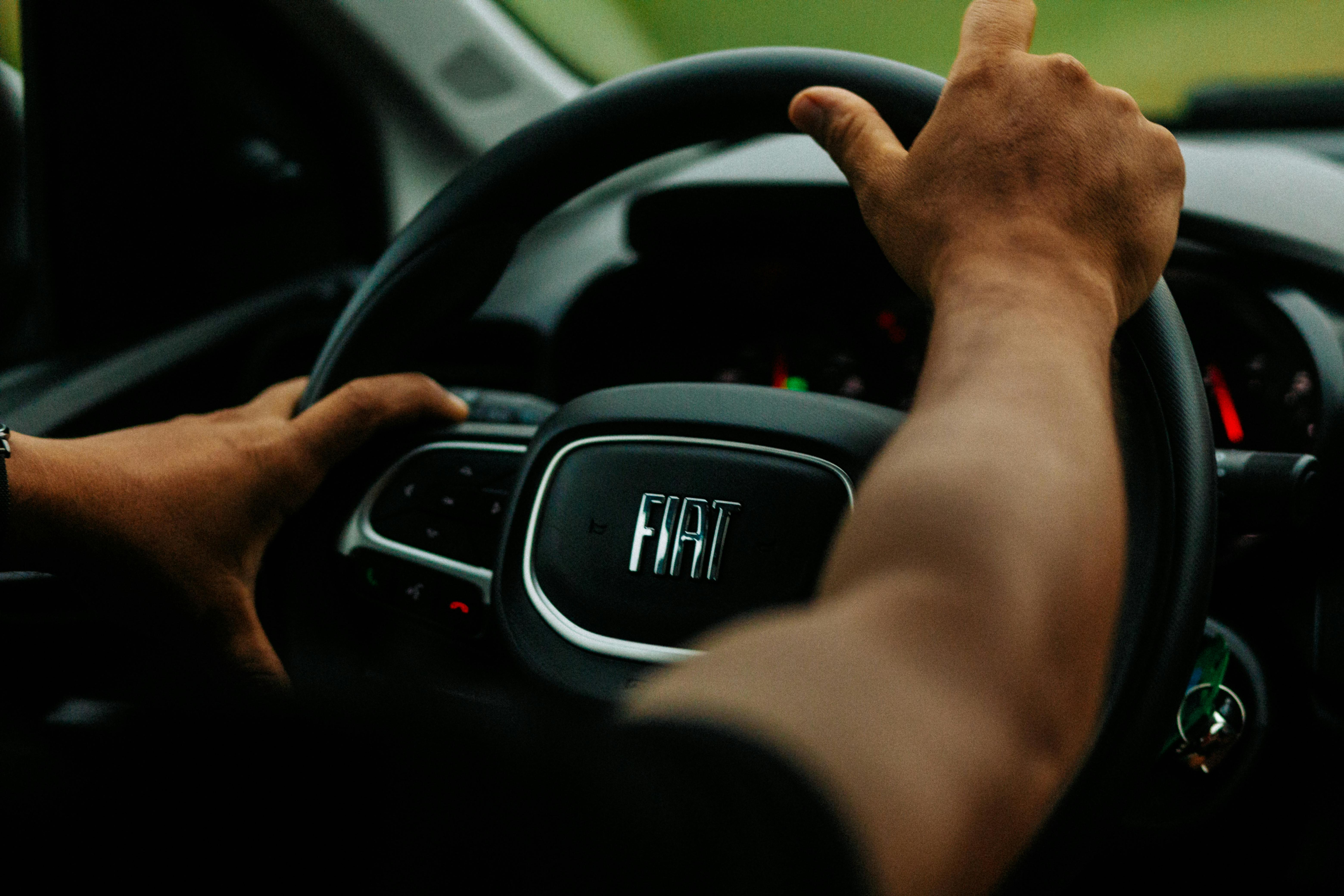 Close-up of a Man Driving a Fiat · Free Stock Photo