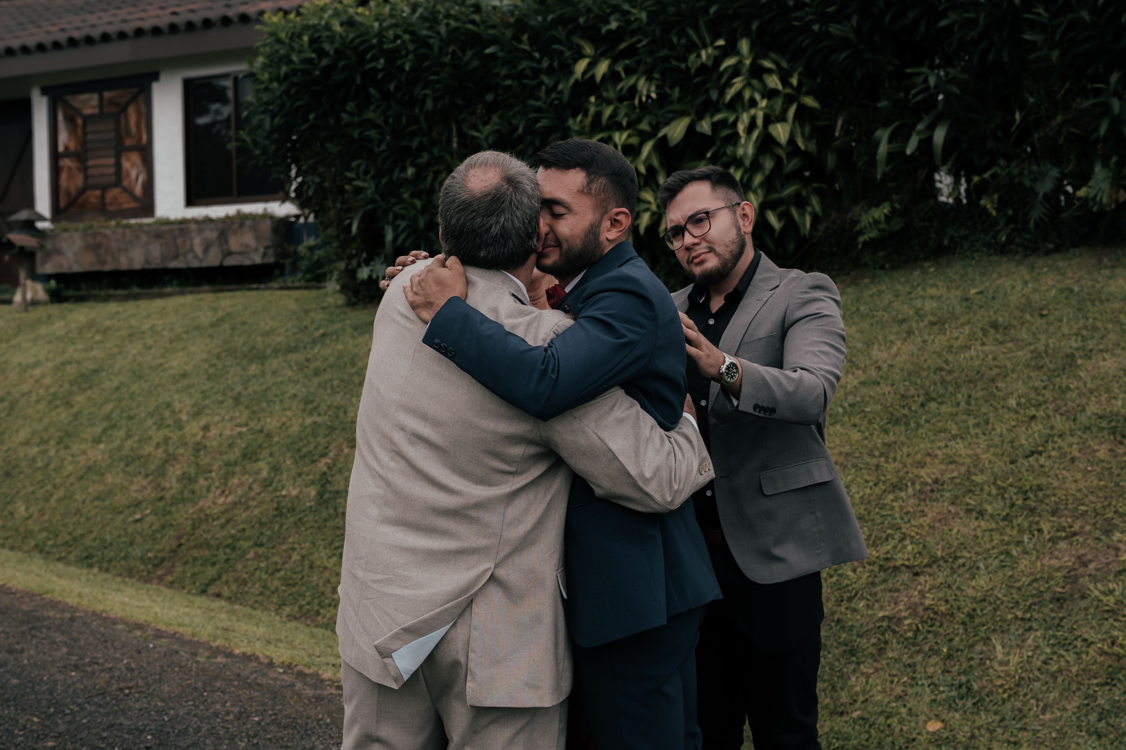 Father and Brother Hugging Groom · Free Stock Photo