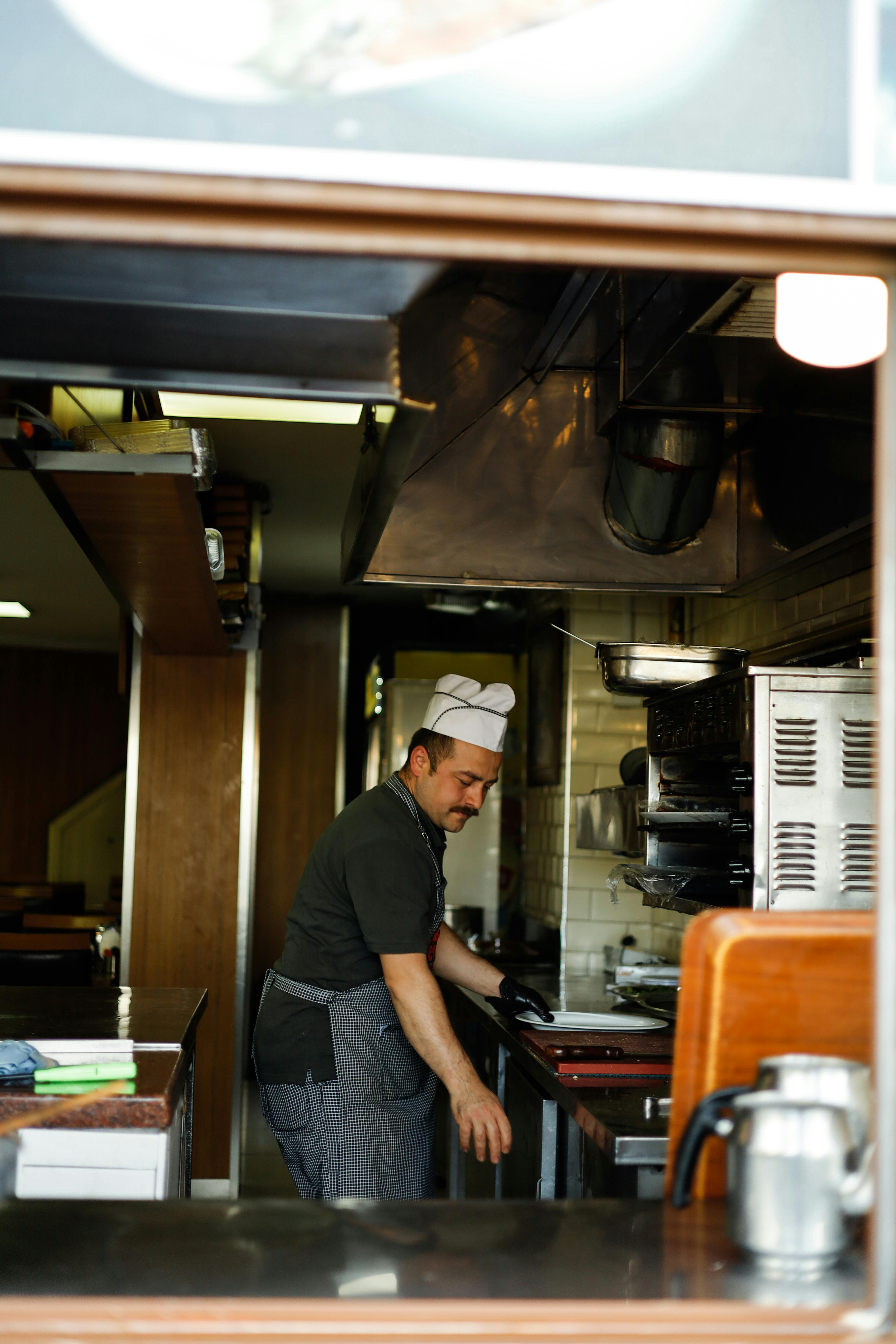 Cook Working in Restaurant Kitchen · Free Stock Photo