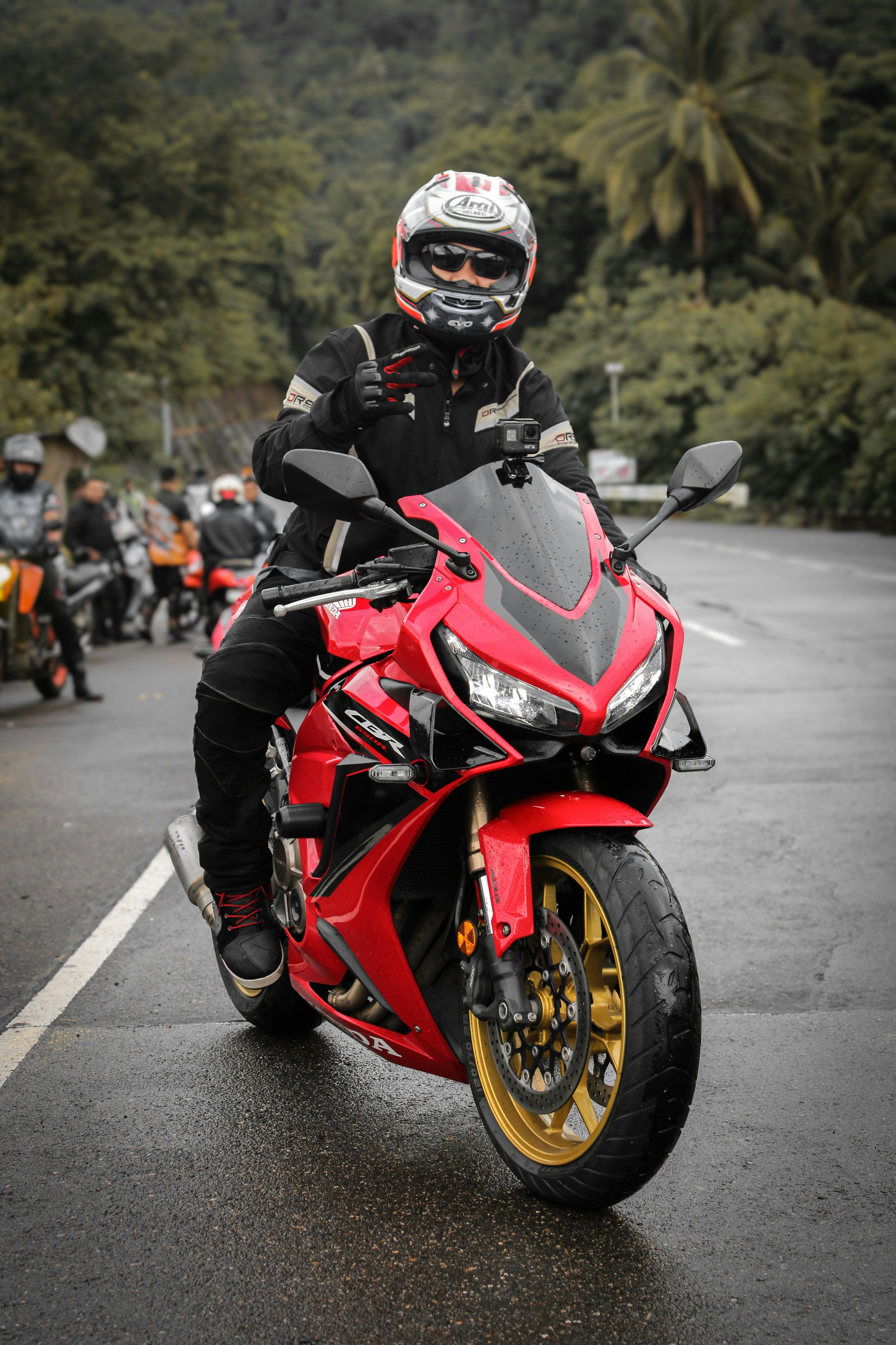 A Man Sitting on a Red Motorcycle · Free Stock Photo