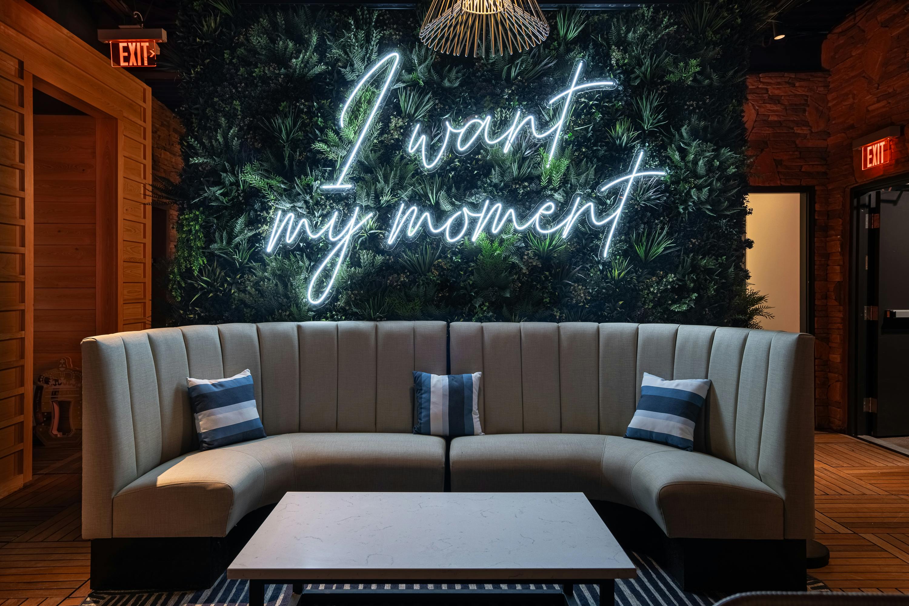 Sofa and Coffee Table by a Wall with a Neon Writing · Free Stock Photo