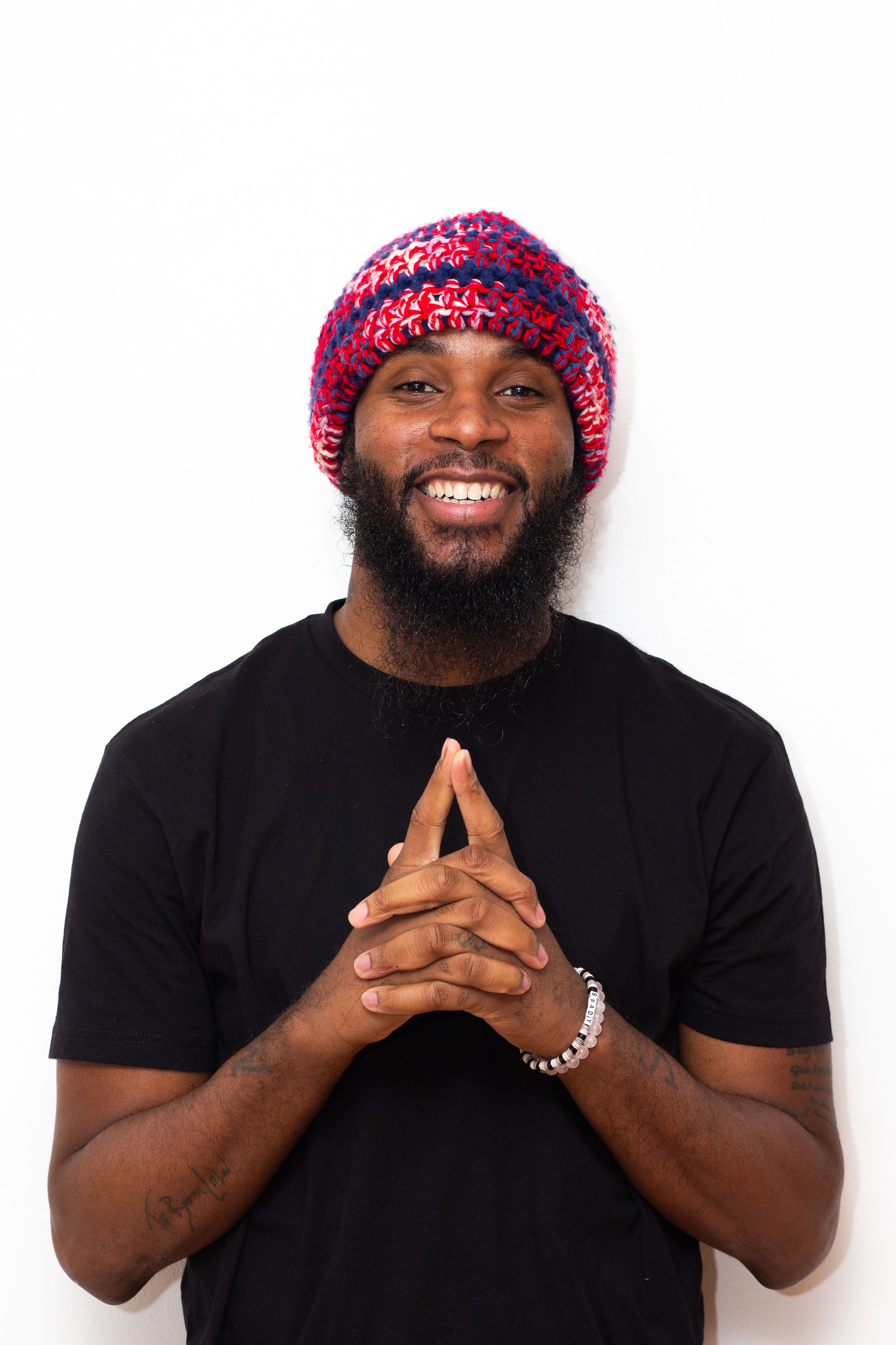 Smiling Young Man in a Hat Showing a Hand Gesture · Free Stock Photo