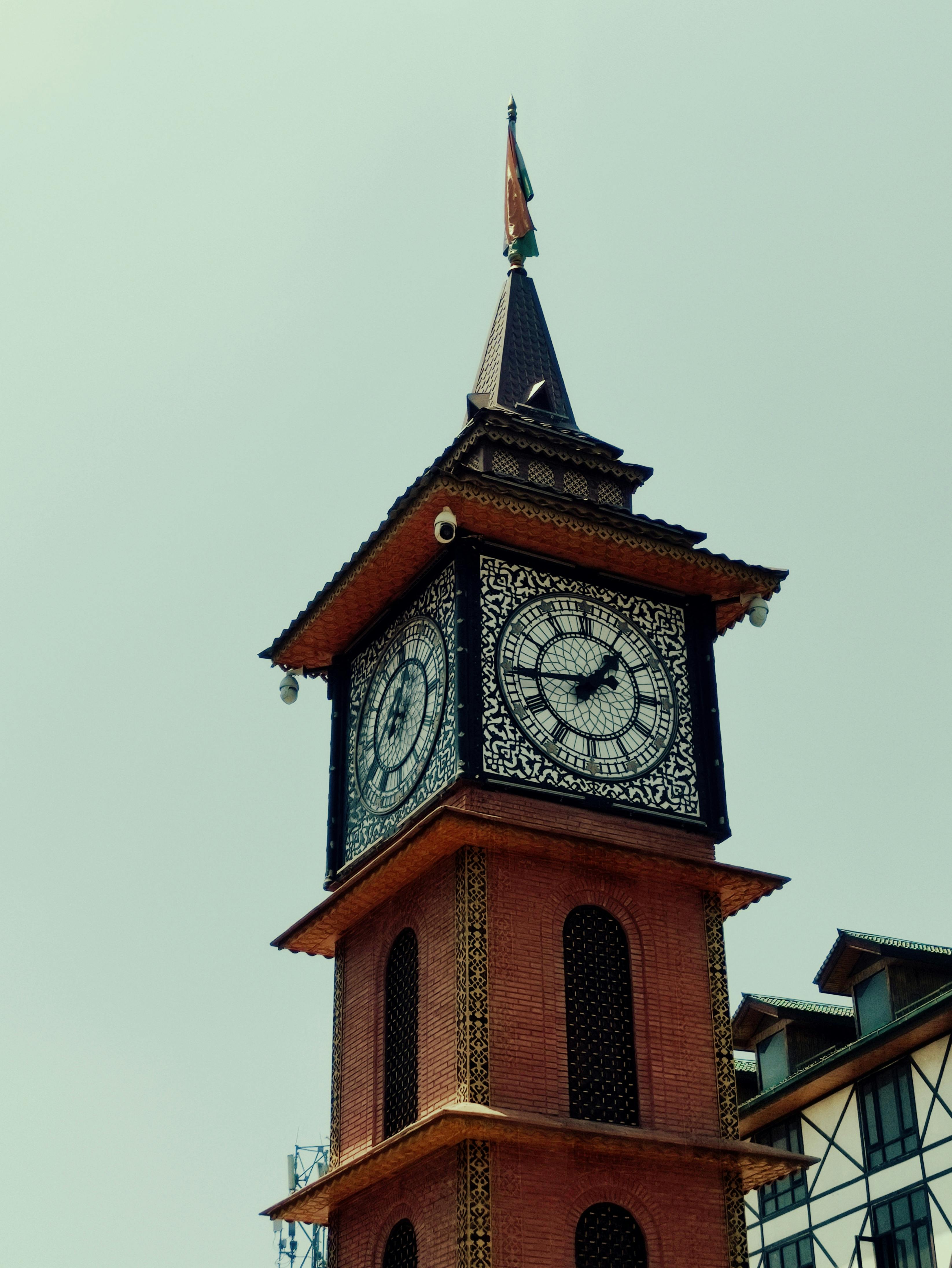 A clock tower with a clock on top · Free Stock Photo